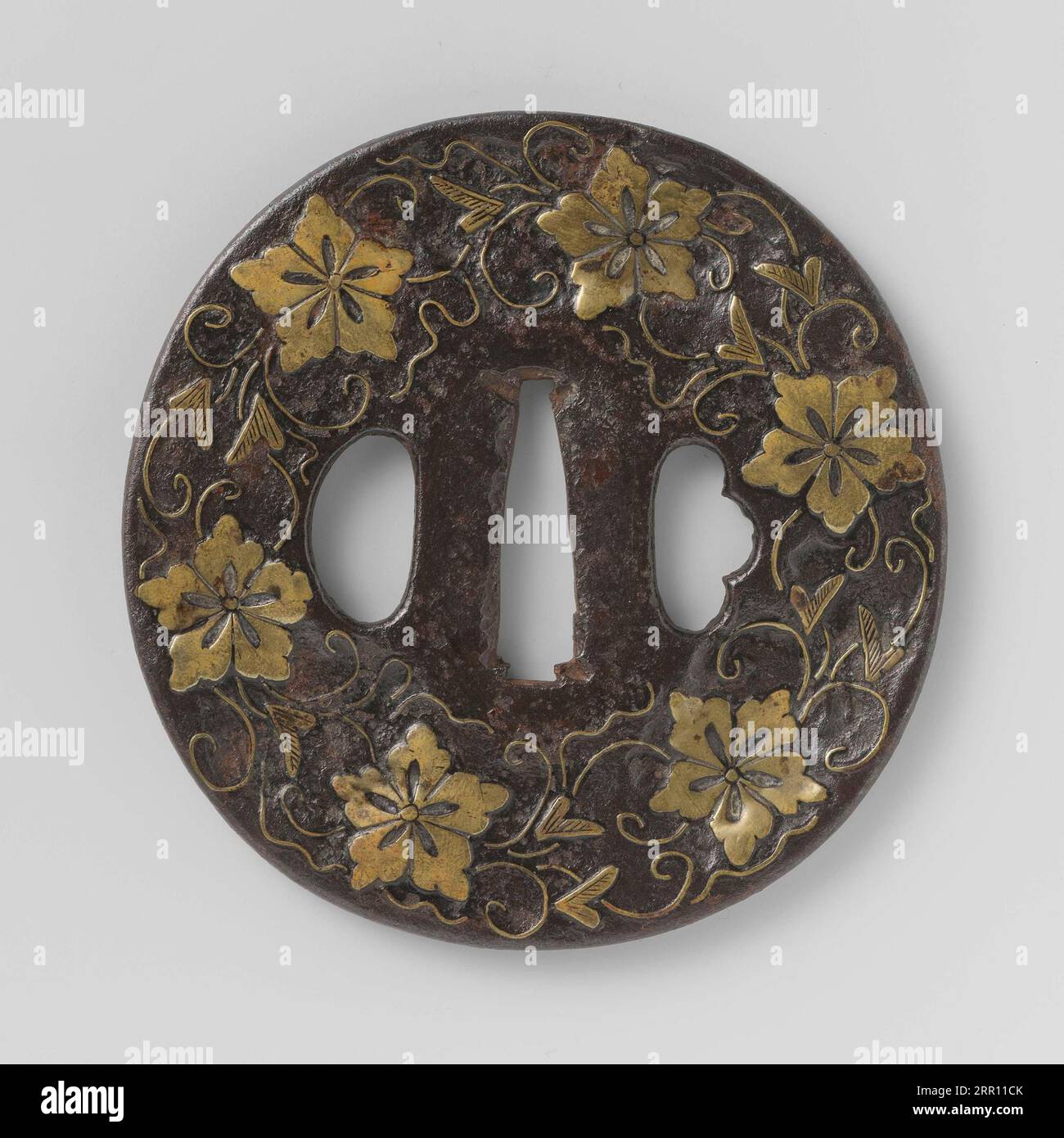 A round oval Iron Tsuba, a sword guard and part of a sword mounting. It ...