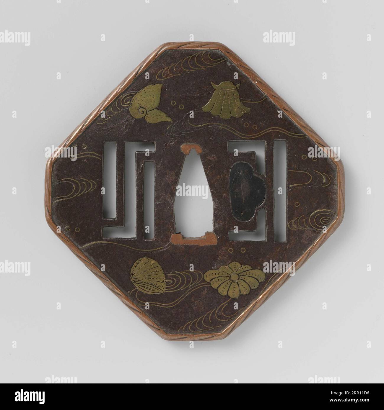 A round oval Iron Tsuba, a sword guard and part of a sword mounting. It ...