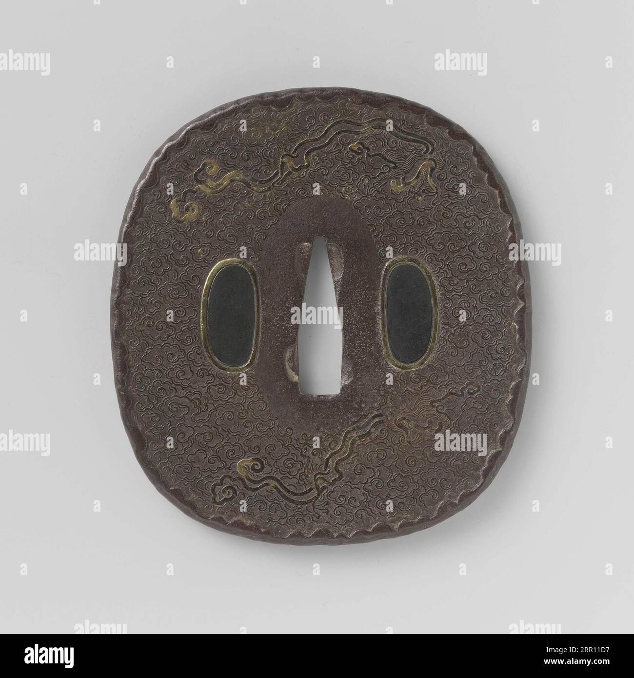 A round oval Iron Tsuba, a sword guard and part of a sword mounting. It ...