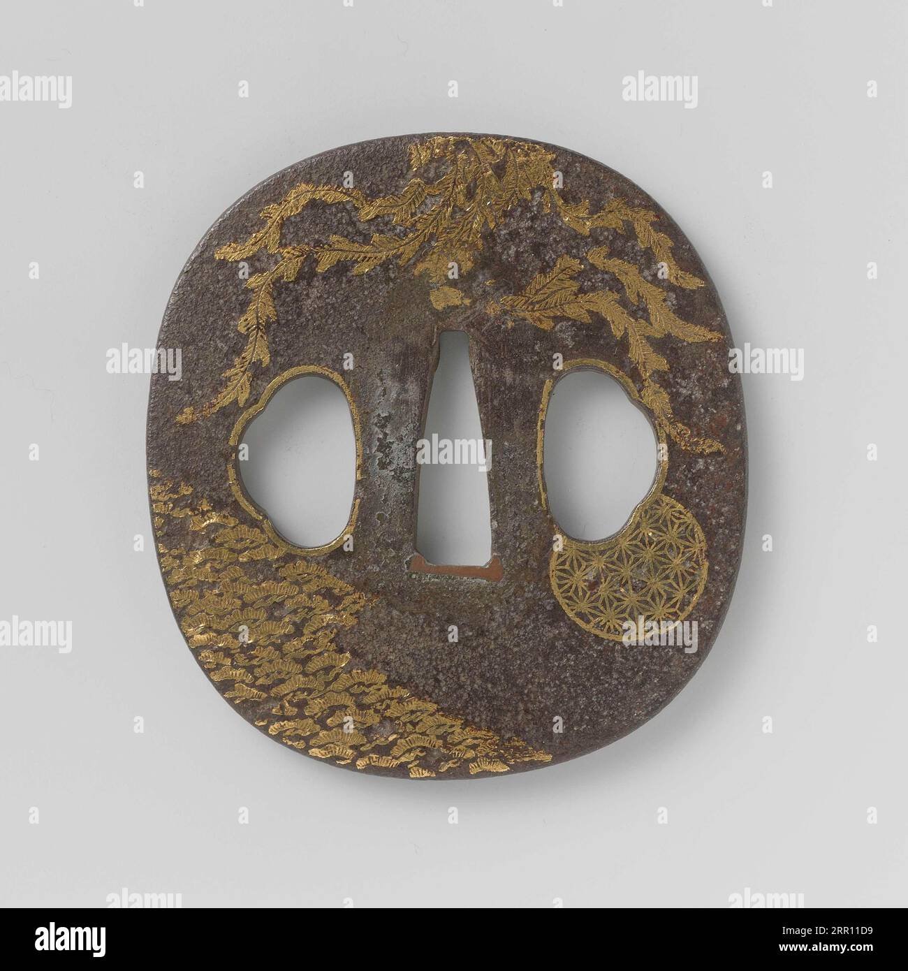 A round oval Iron Tsuba, a sword guard and part of a sword mounting. It ...