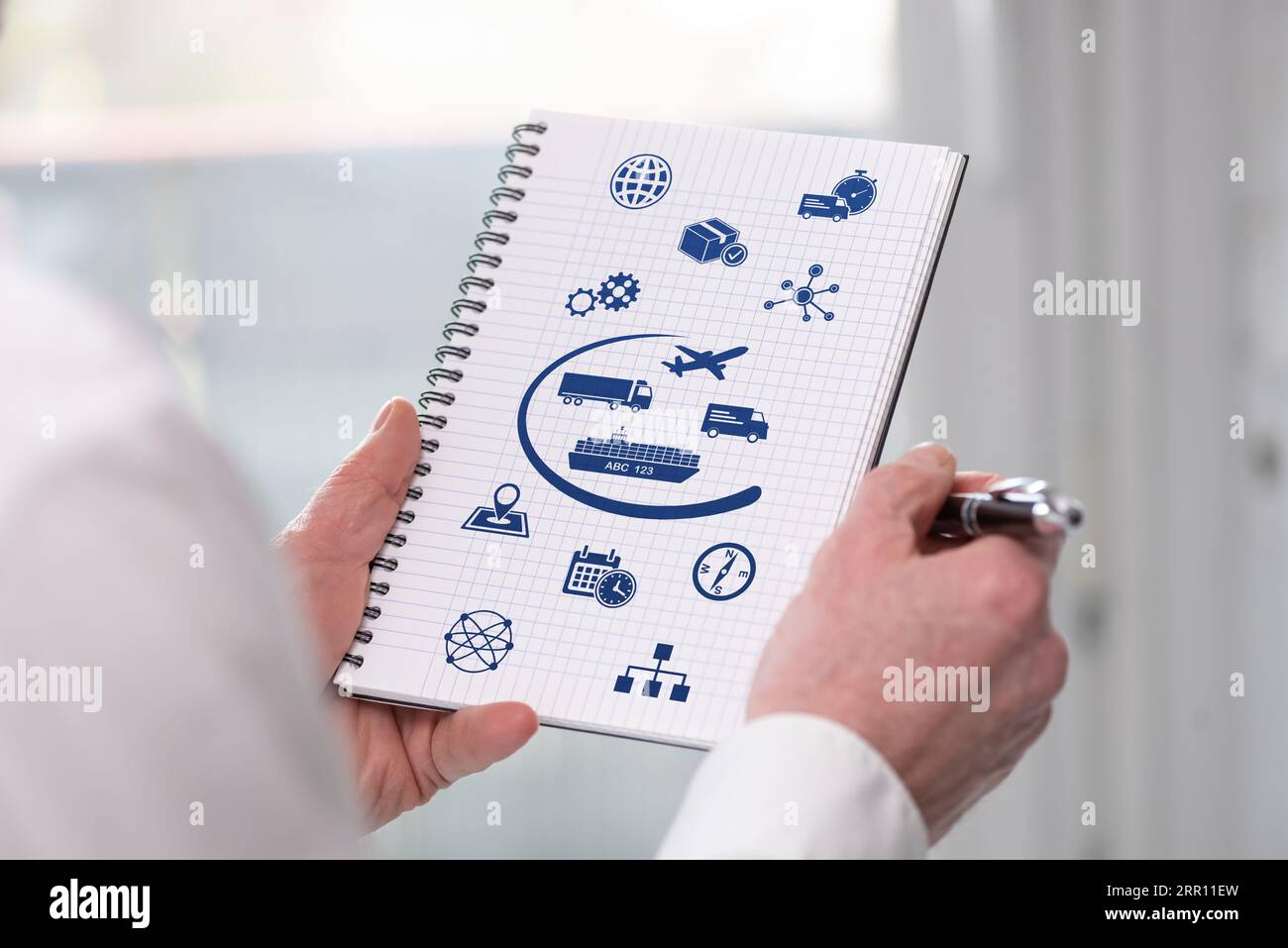Hand holding a notepad with transportation concept Stock Photo - Alamy