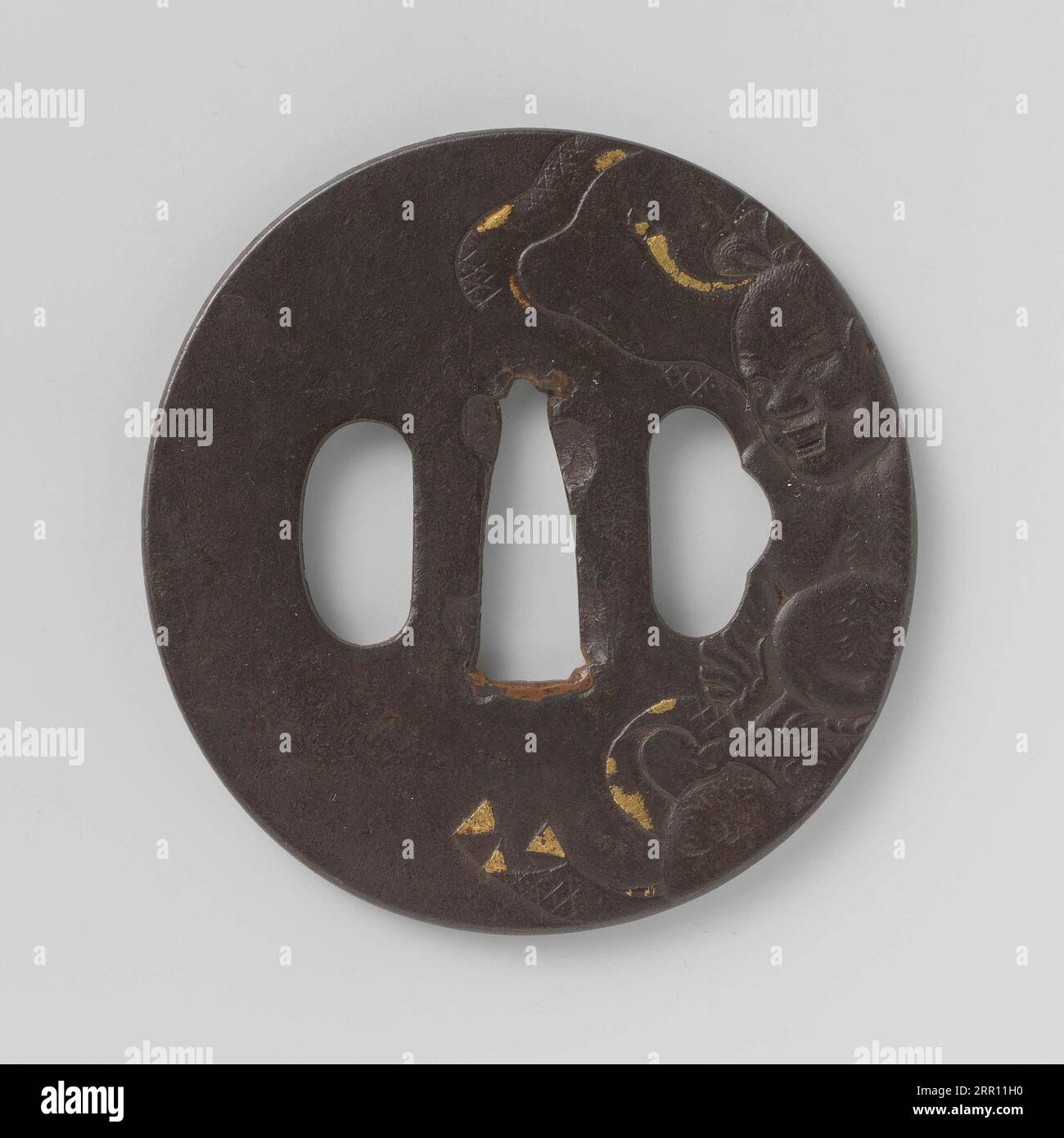 A round oval Iron Tsuba, a sword guard and part of a sword mounting. It ...