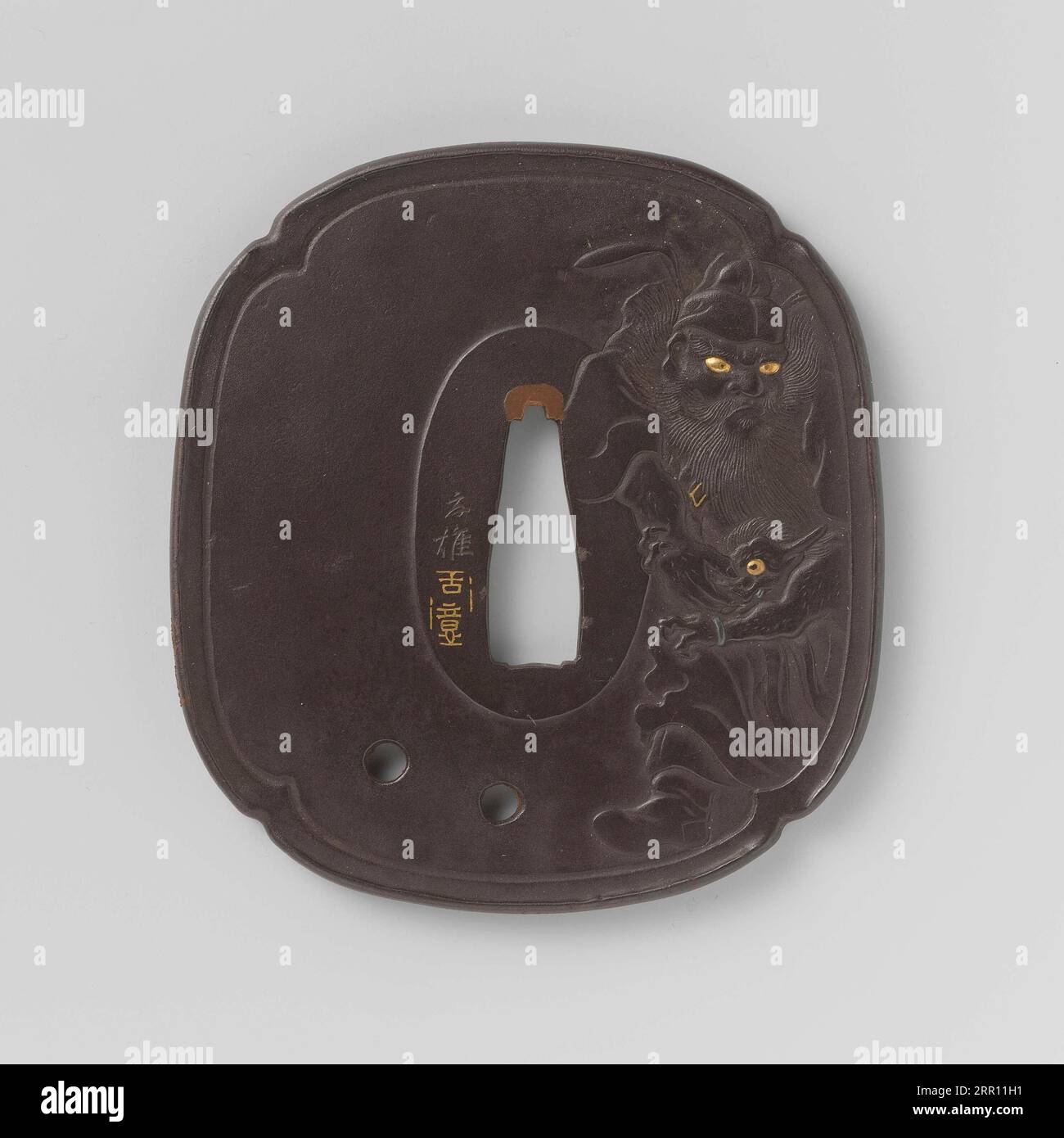 A round oval Iron Tsuba, a sword guard and part of a sword mounting. It ...