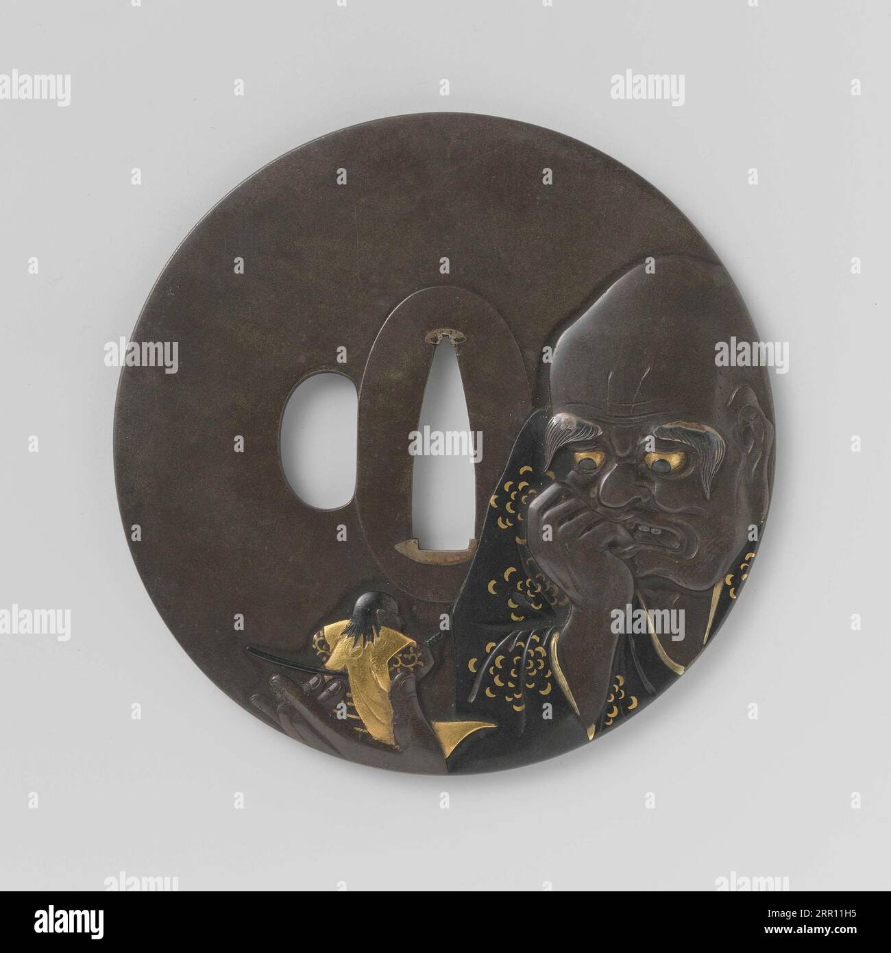 A round oval Iron Tsuba, a sword guard and part of a sword mounting. It ...