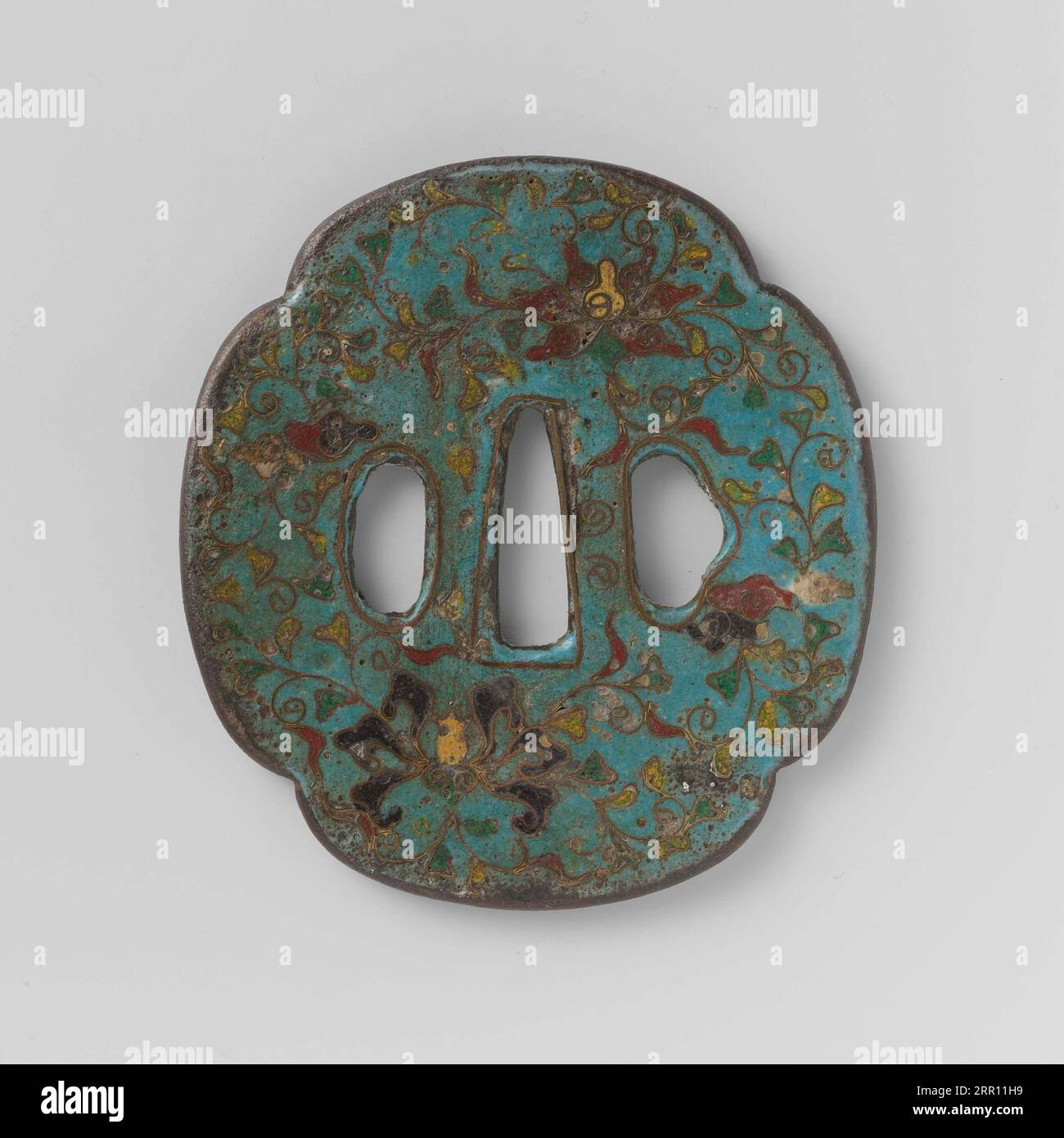 A round oval Iron Tsuba, a sword guard and part of a sword mounting. It ...