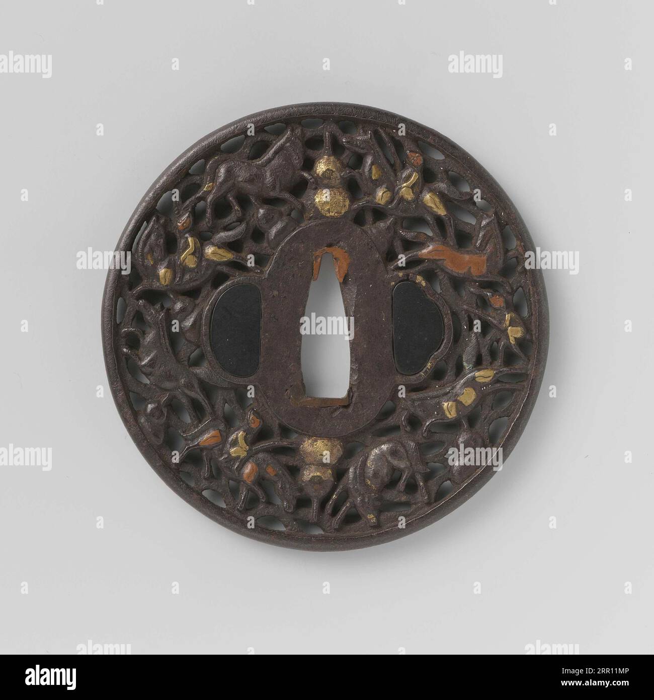 A round oval Iron Tsuba, a sword guard and part of a sword mounting. It ...