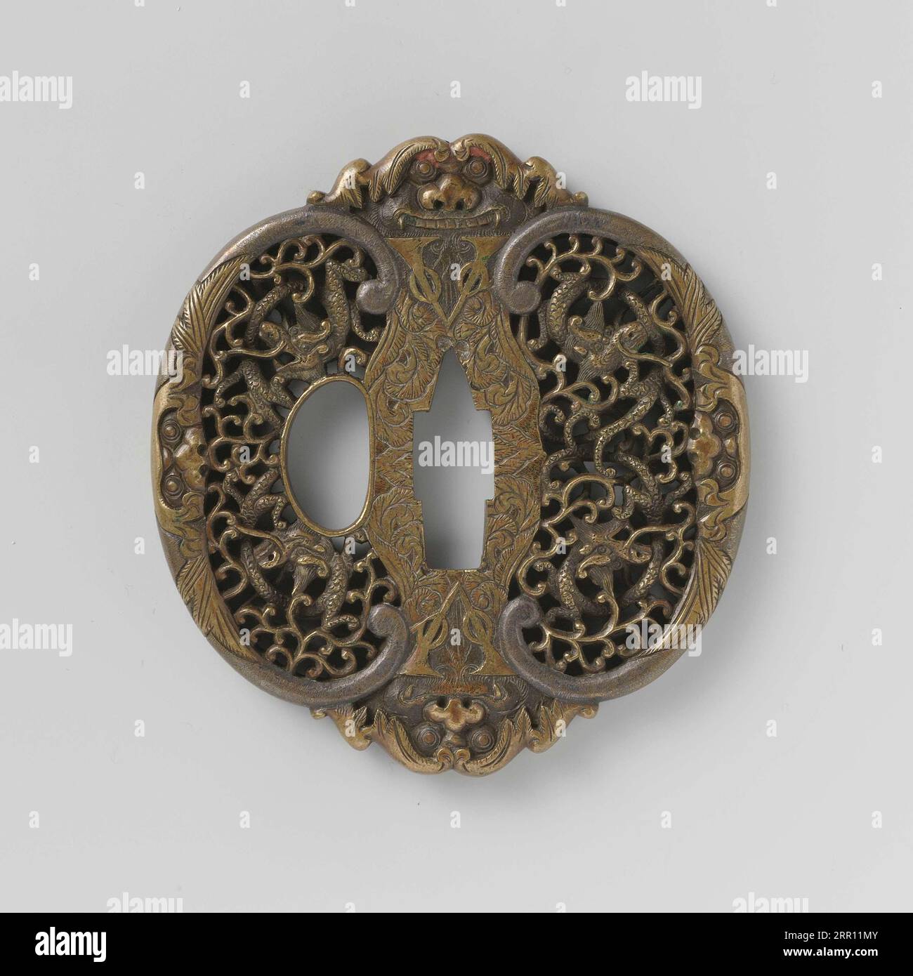 A round oval Iron Tsuba, a sword guard and part of a sword mounting. It ...