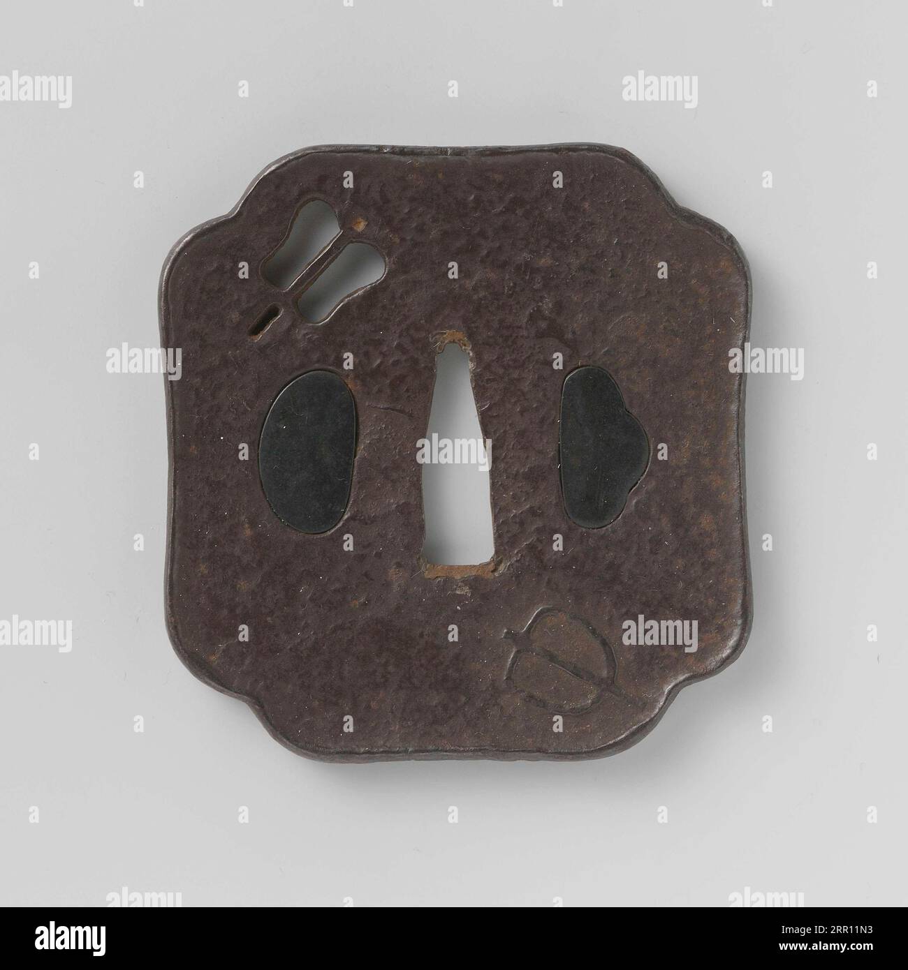 A round oval Iron Tsuba, a sword guard and part of a sword mounting. It ...