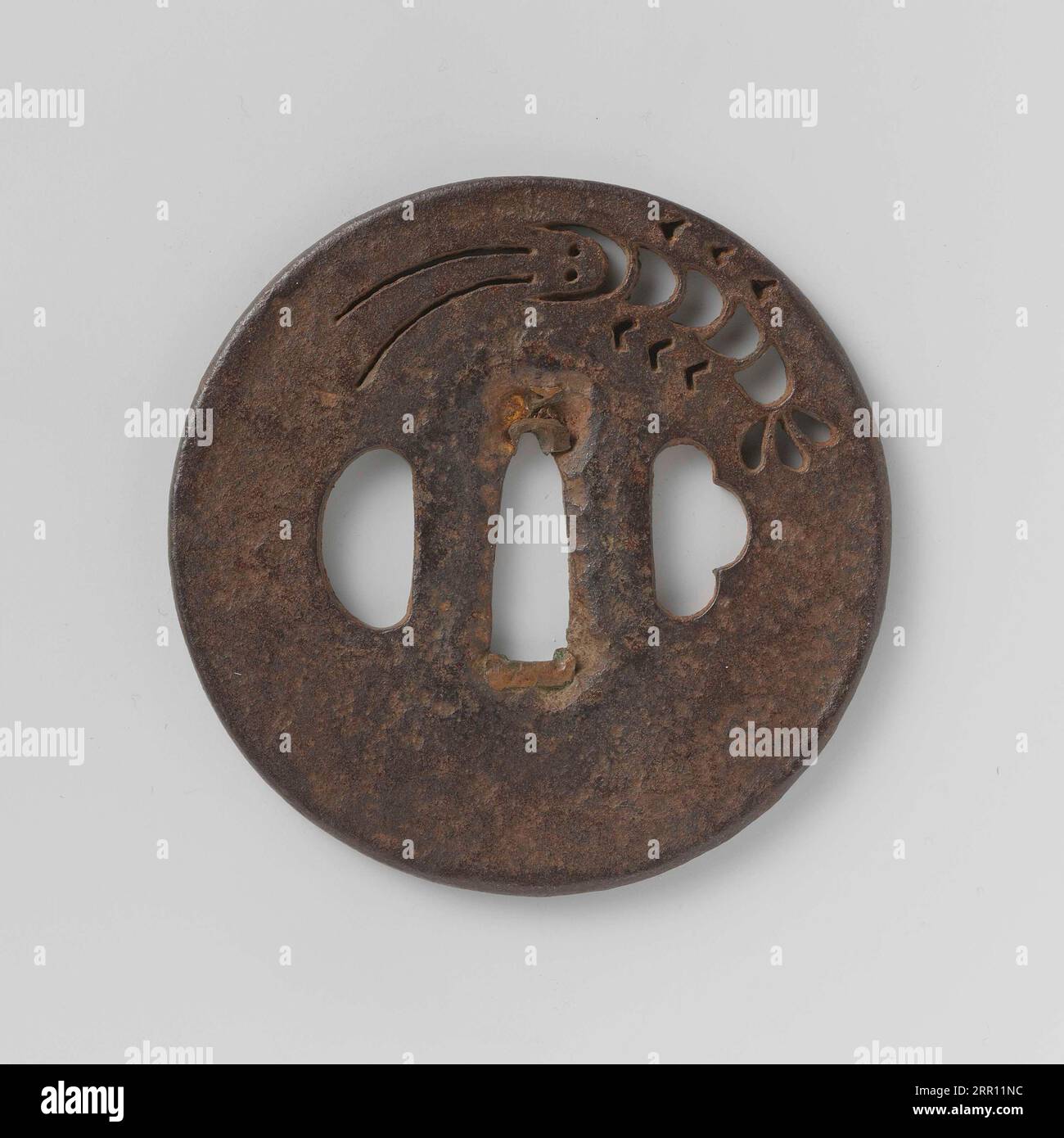A round oval Iron Tsuba, a sword guard and part of a sword mounting. It ...