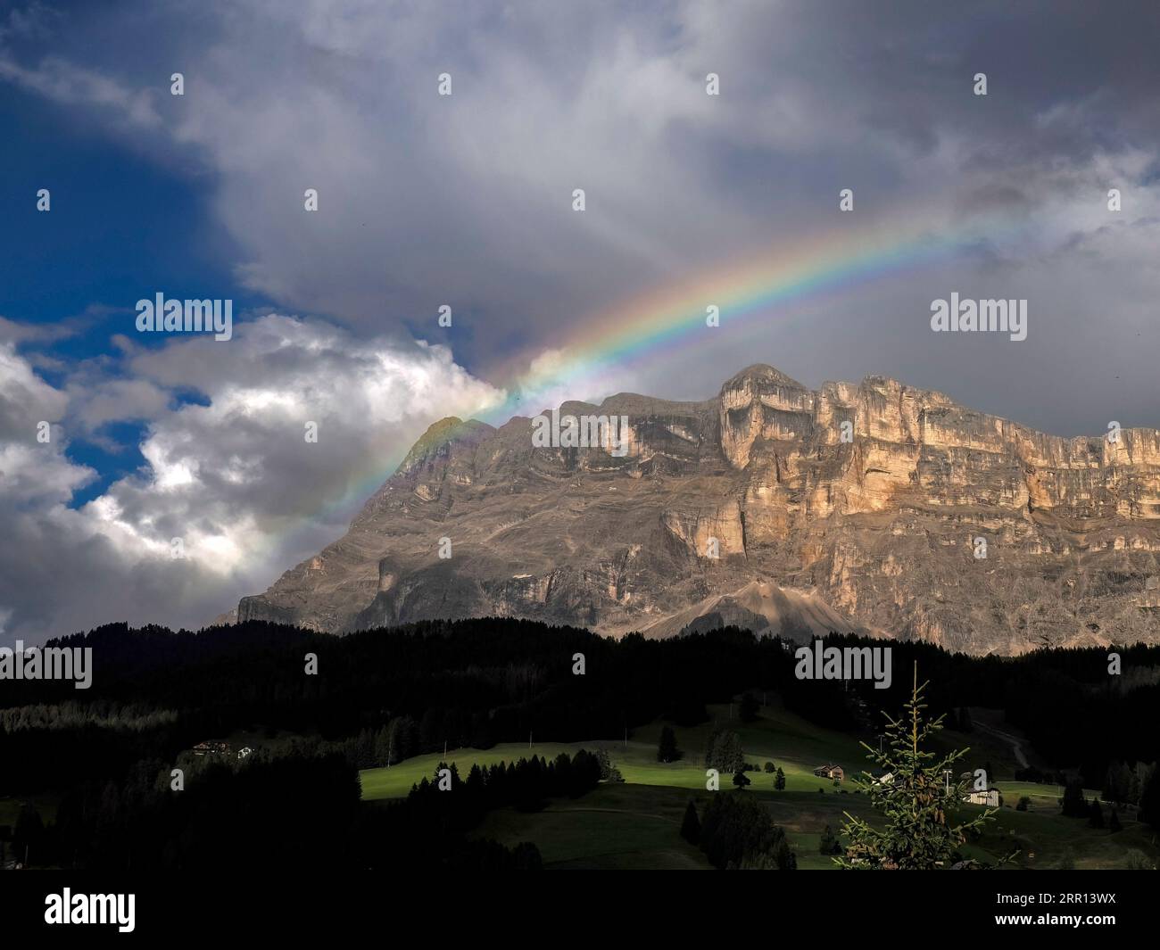 rainbow on the monte croce cross mountain in dolomites badia valley ...