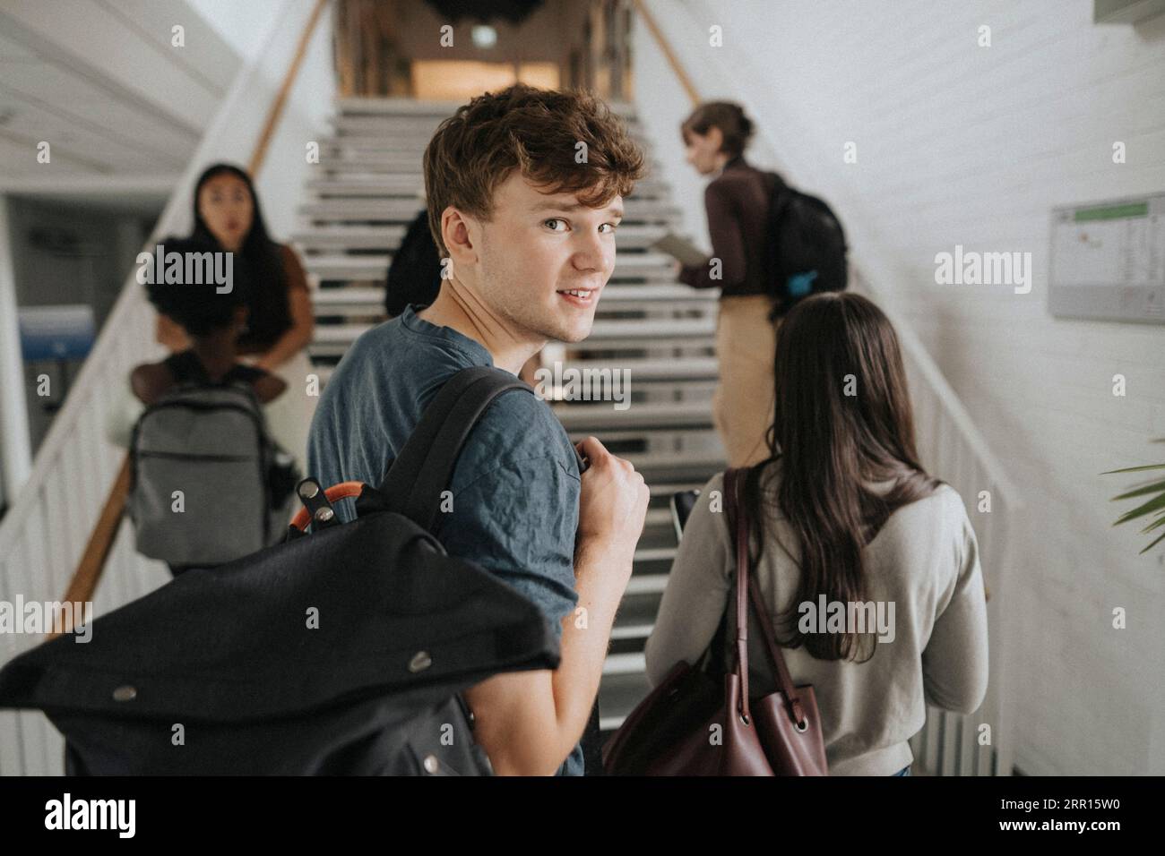 Portrait of smiling male student with friends at university Stock Photo ...