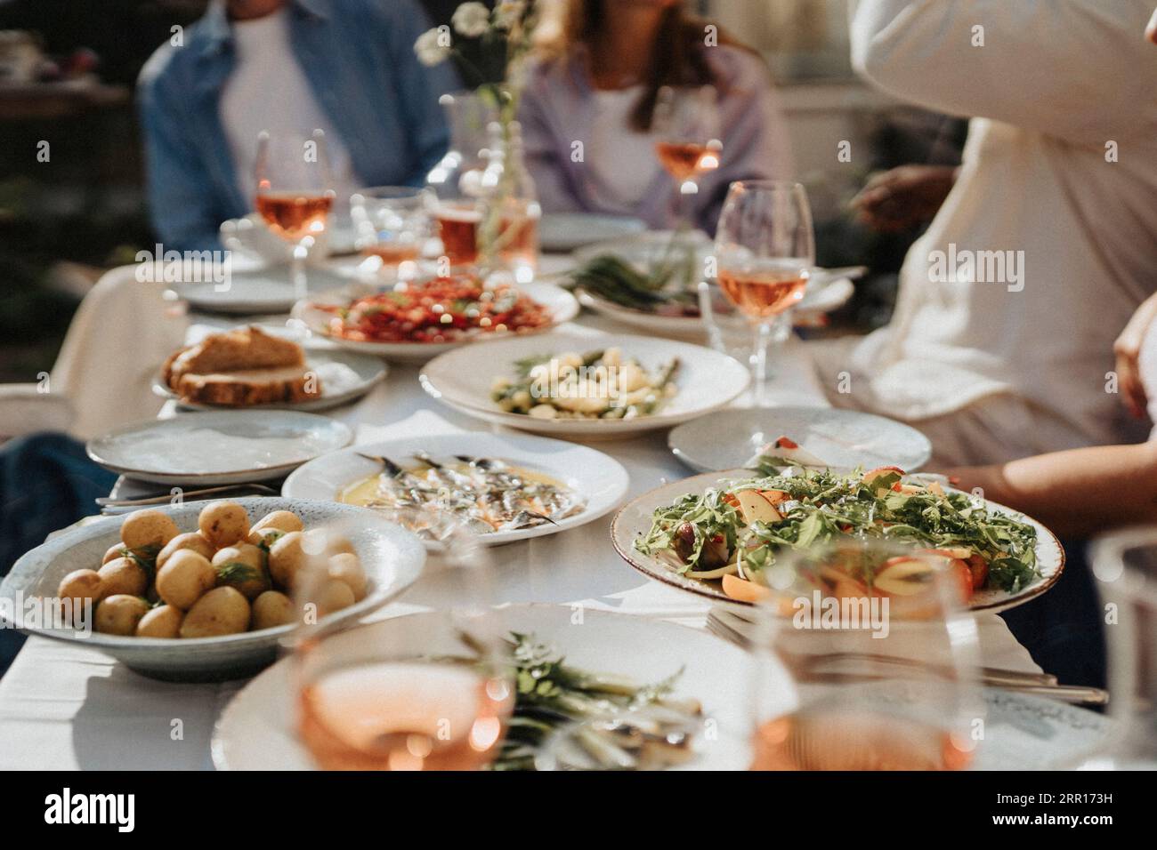 Food and salad with drinks arranged on table during dinner party at ...