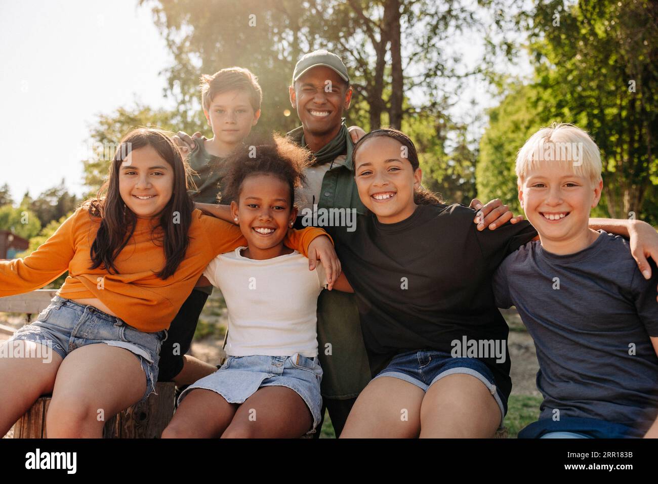 Portrait of male camp counselor with happy kids at summer camp Stock ...