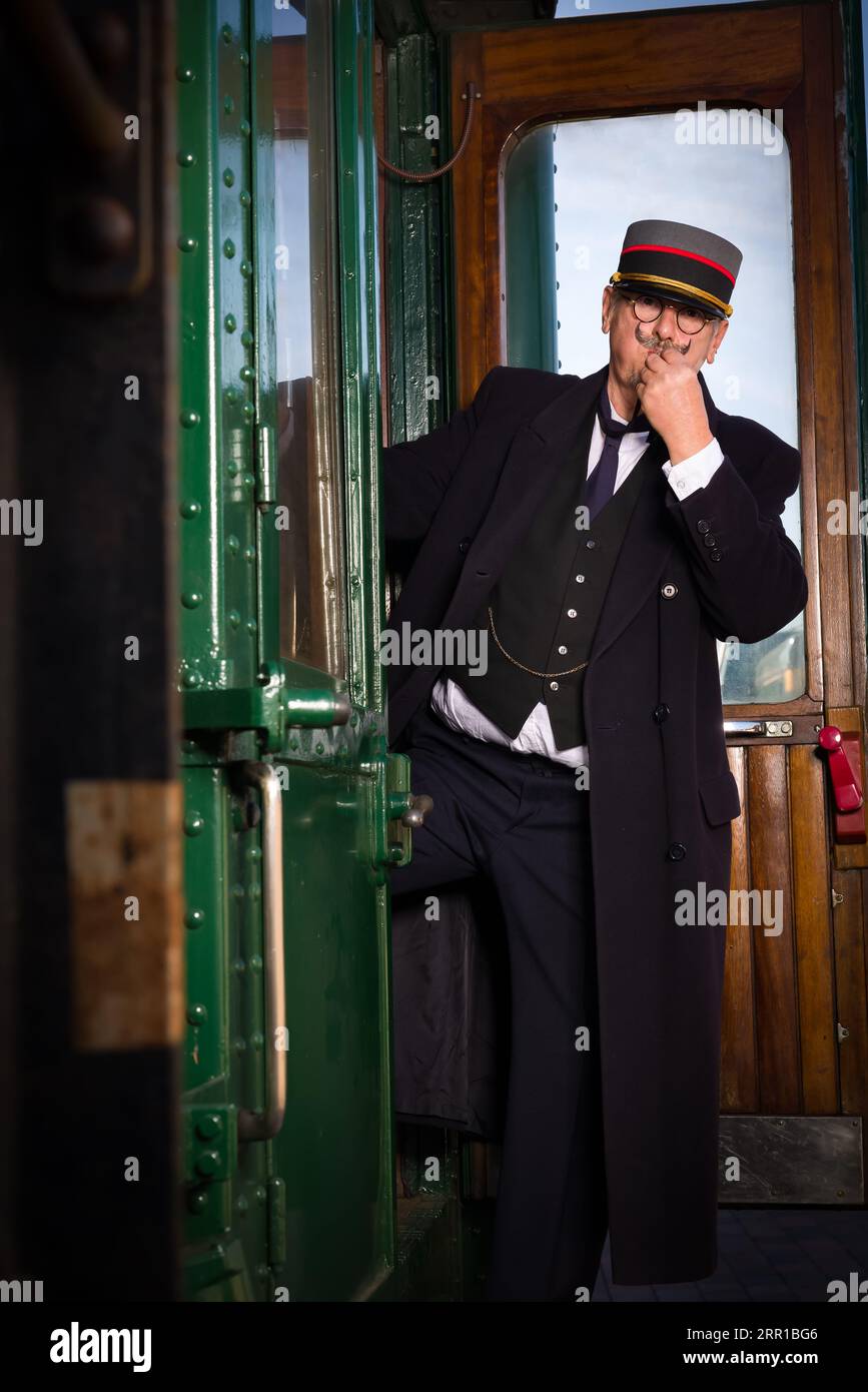 Reenactment scene with authentic 1927 1st class train carriage and a ...