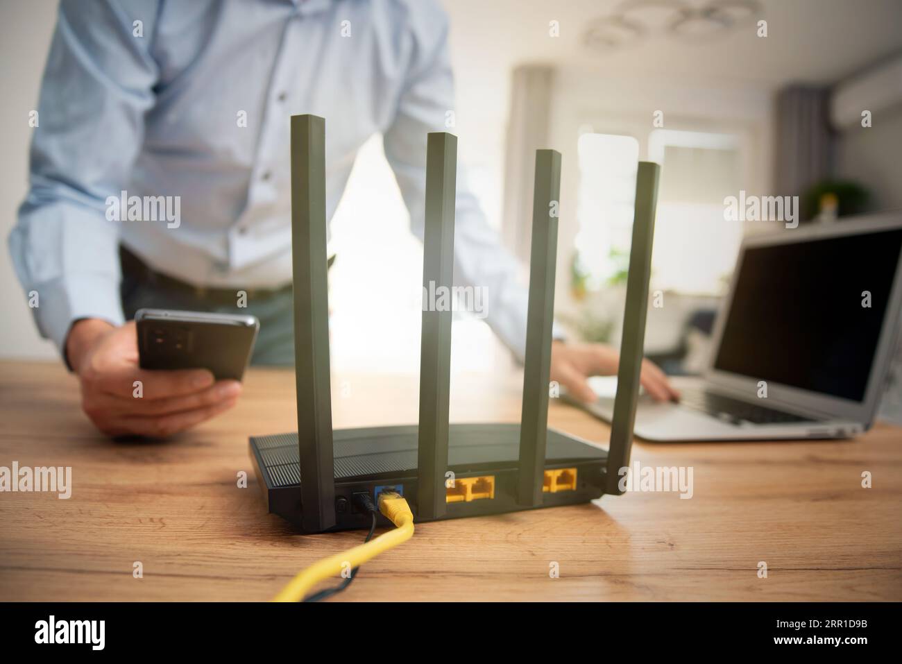Fast and wireless internet concept with home router. Man using ...