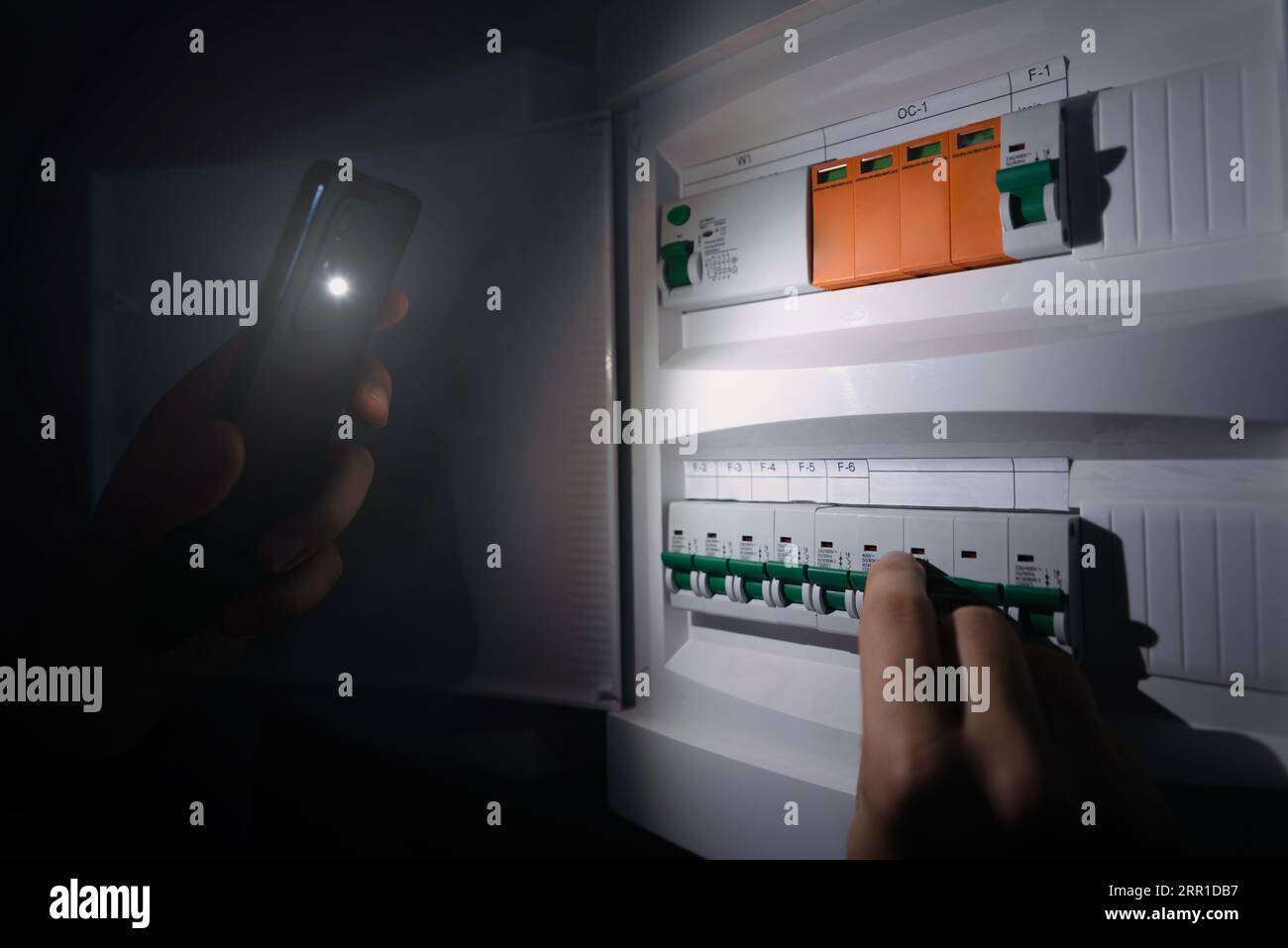 Blackout concept, energy crisis. Hand holding a flashlight to ...