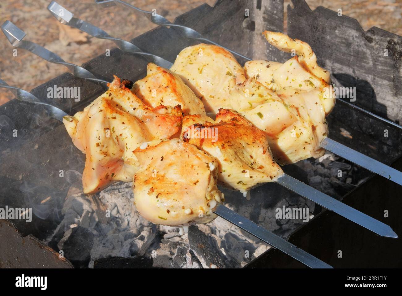 Meat frying on grill. Fried pieces of pork and beef skewers on coals in ...