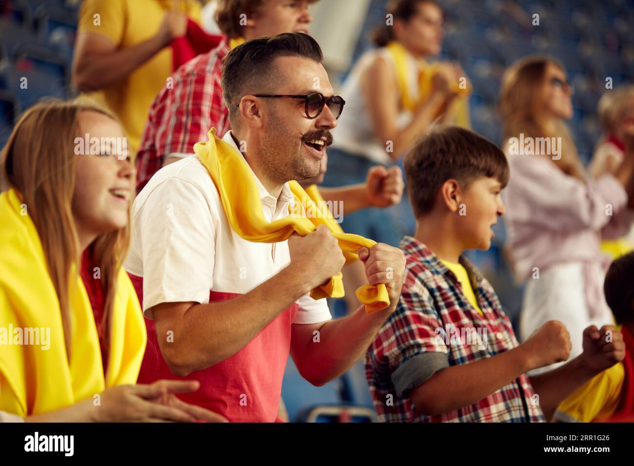 Young emotional people, sport fans attending live football match to ...