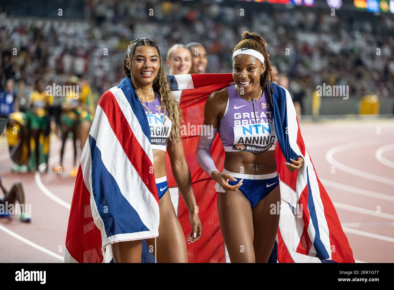 Amber Anning and Nicole Yeargin with her country's flag in the 4x400 ...