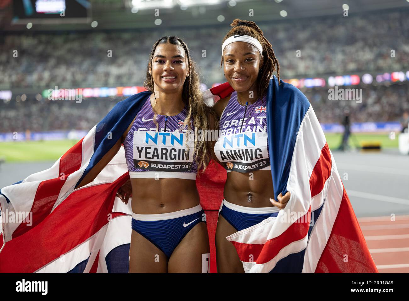 Amber Anning and Nicole Yeargin with her country's flag in the 4x400 ...