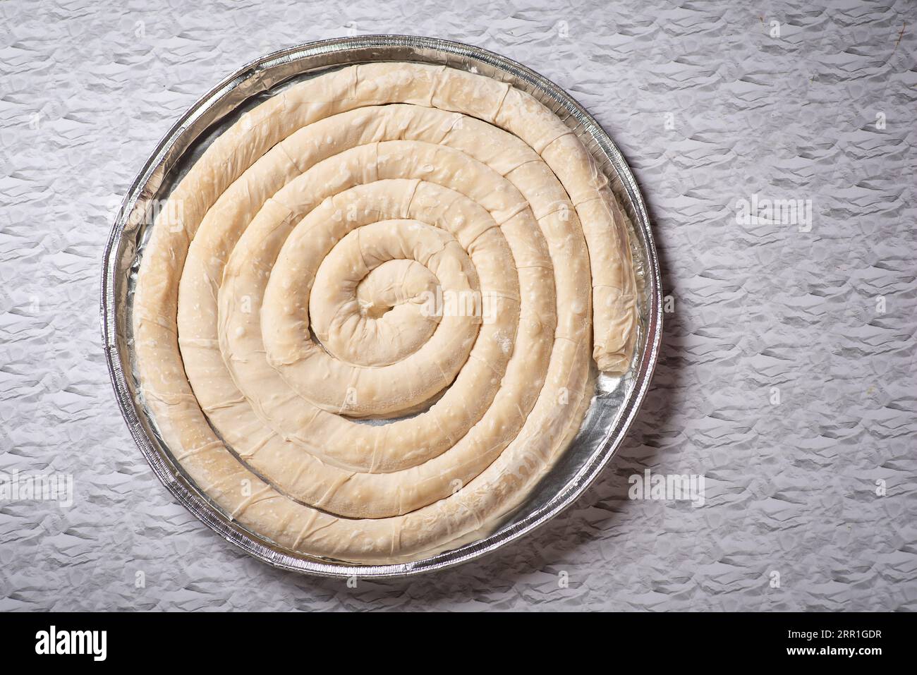 Traditional Greek pie. Snail with cheese. Roll with cheese filling on a ...