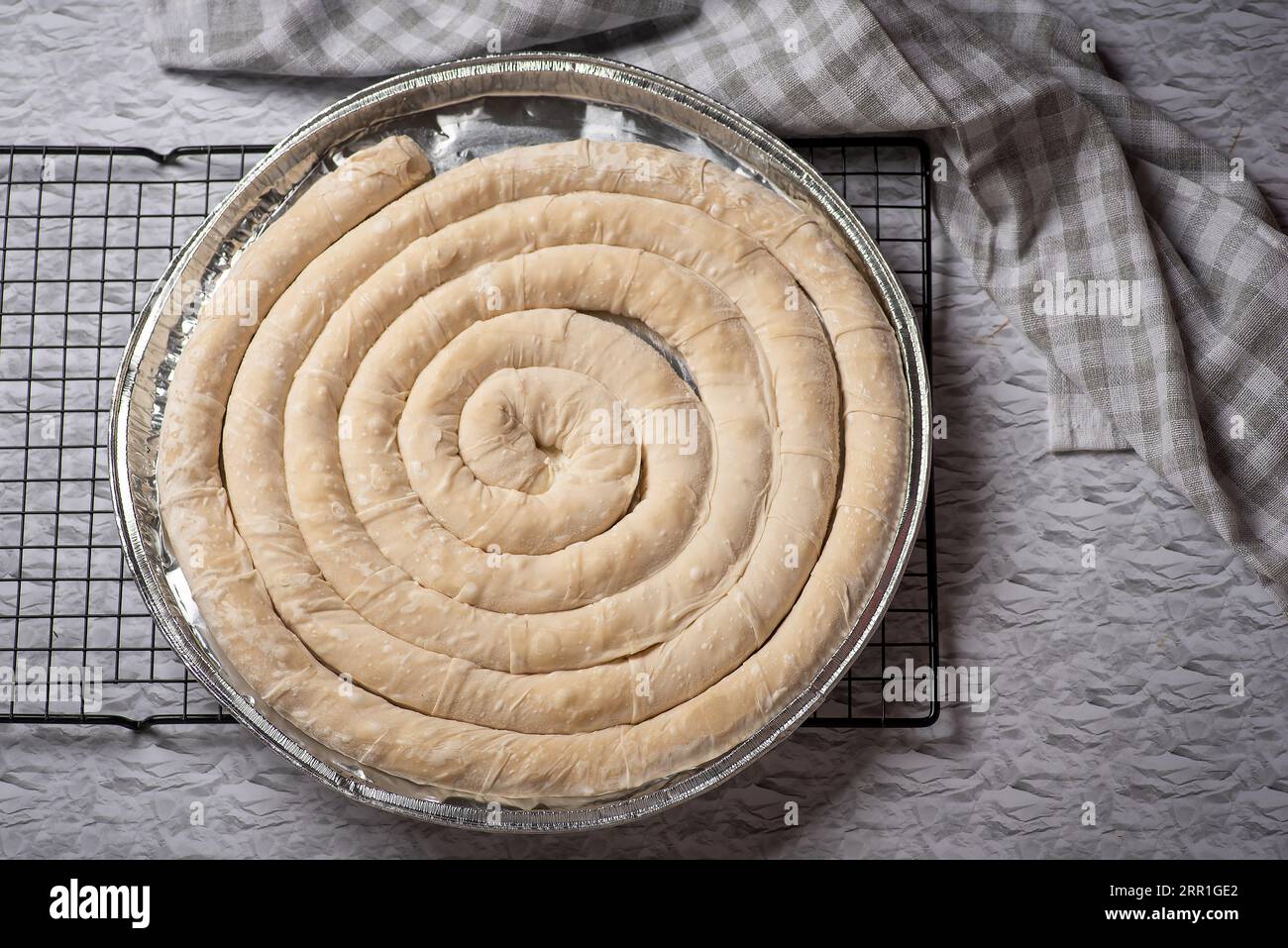 Traditional Greek pie. Snail with cheese. Roll with cheese filling on a ...