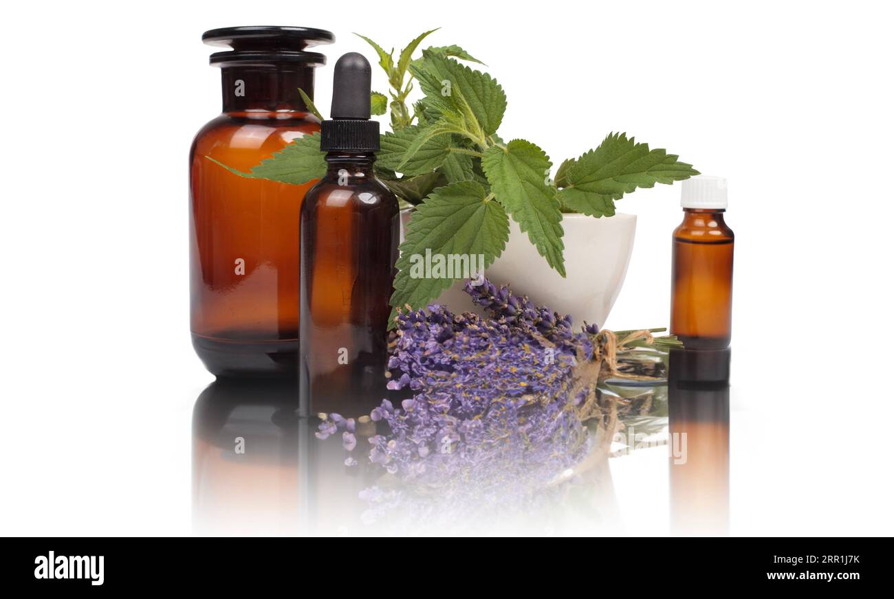 A collection of medical tools, fresh nettle leaves in a mortar, and ...