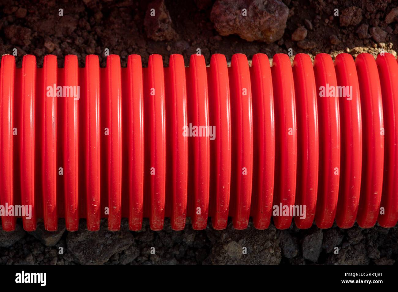 Red plumbing pipe close-up. Drainage, tubing, pipes. Red pipes of the water supply and heating ...