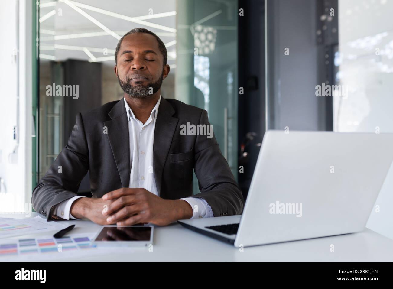 Balanced and calm man at workplace inside office, businessman ...