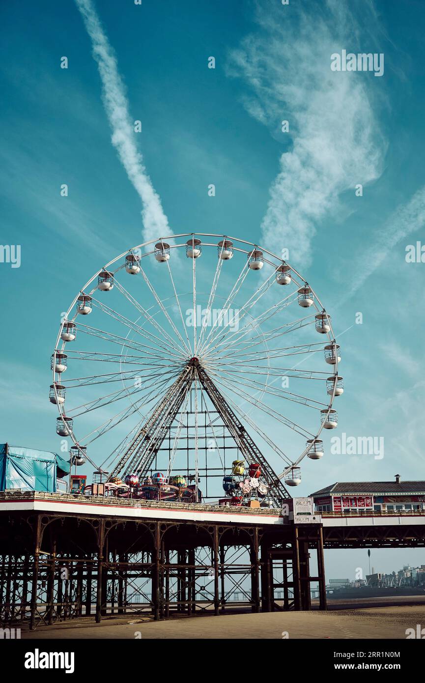 Blackpool Central Pier Ferris wheel with clouds and vapour trails in ...