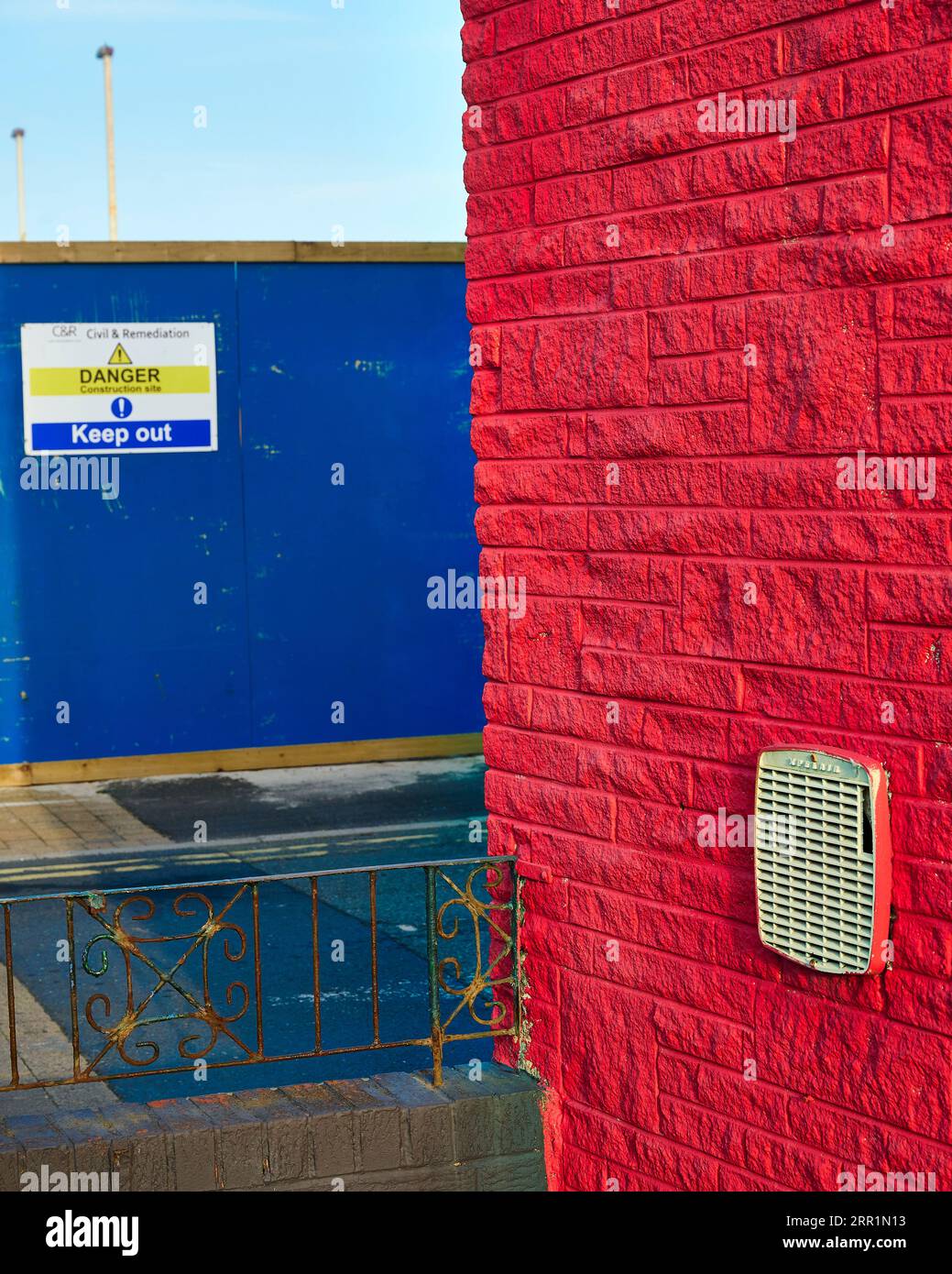 Red brick wall and blue fence Stock Photo - Alamy