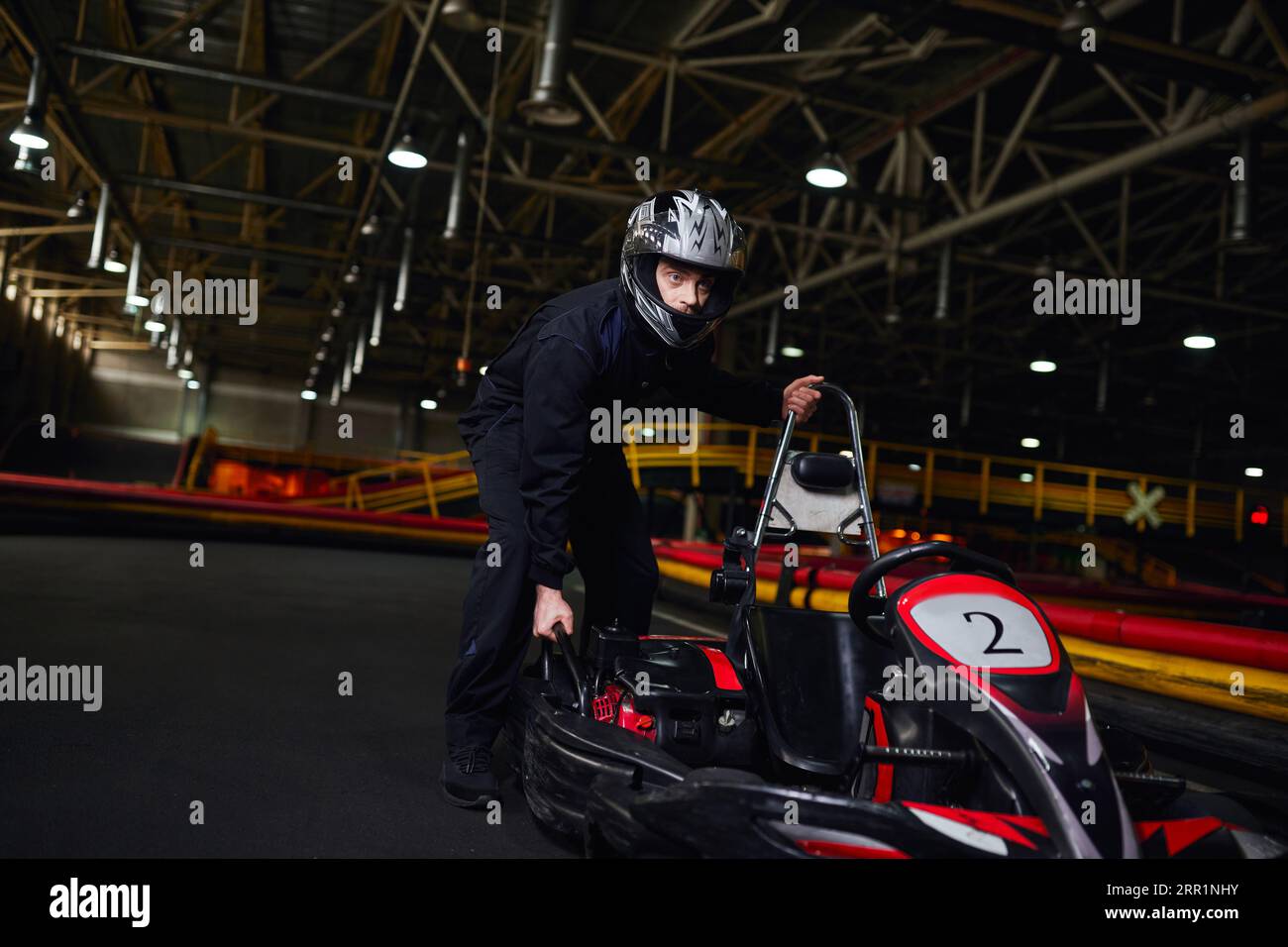 motorsport and speed drive, focused kart driver in sportswear and ...