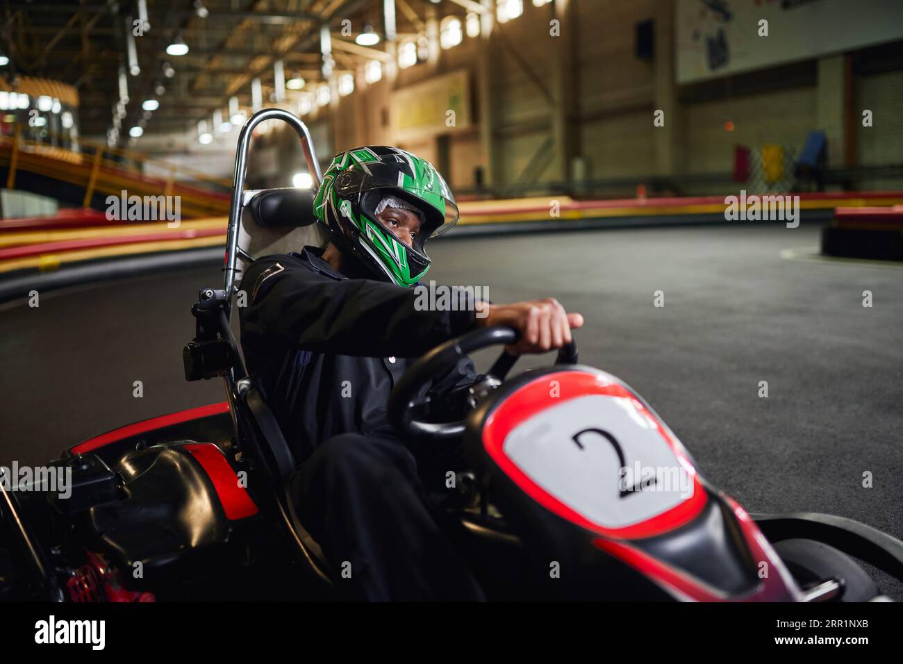 go kart speed drive, focused african american driver in helmet on ...