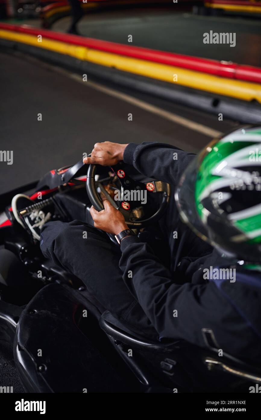 go cart speed drive, african american driver in helmet holding steering ...