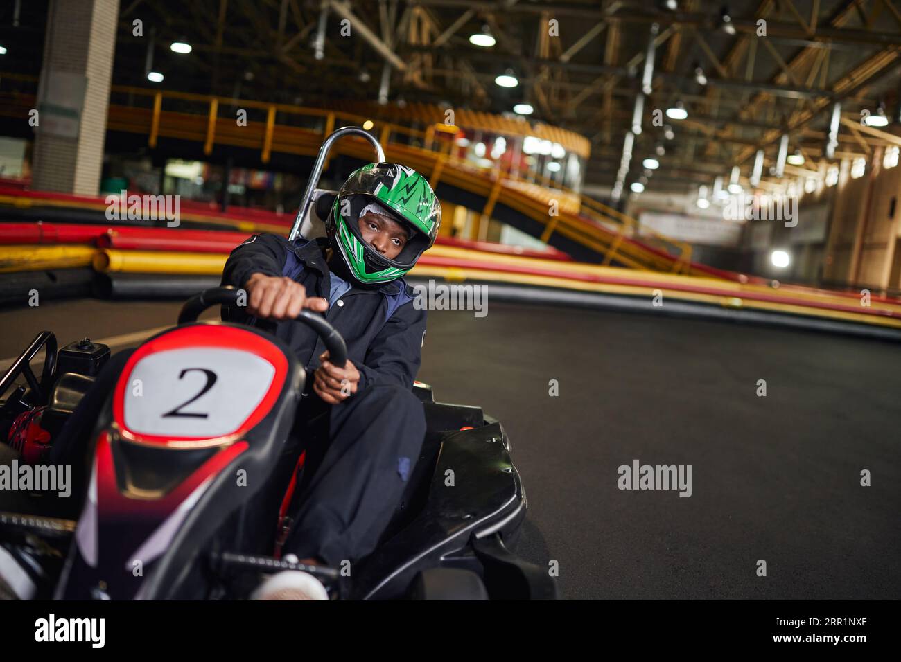 go cart speed drive, african american driver in helmet on circuit ...