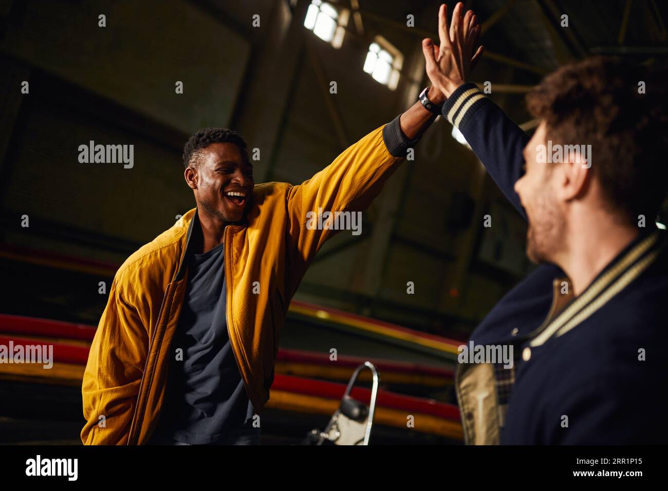 excited african american man giving high five to friend inside of ...