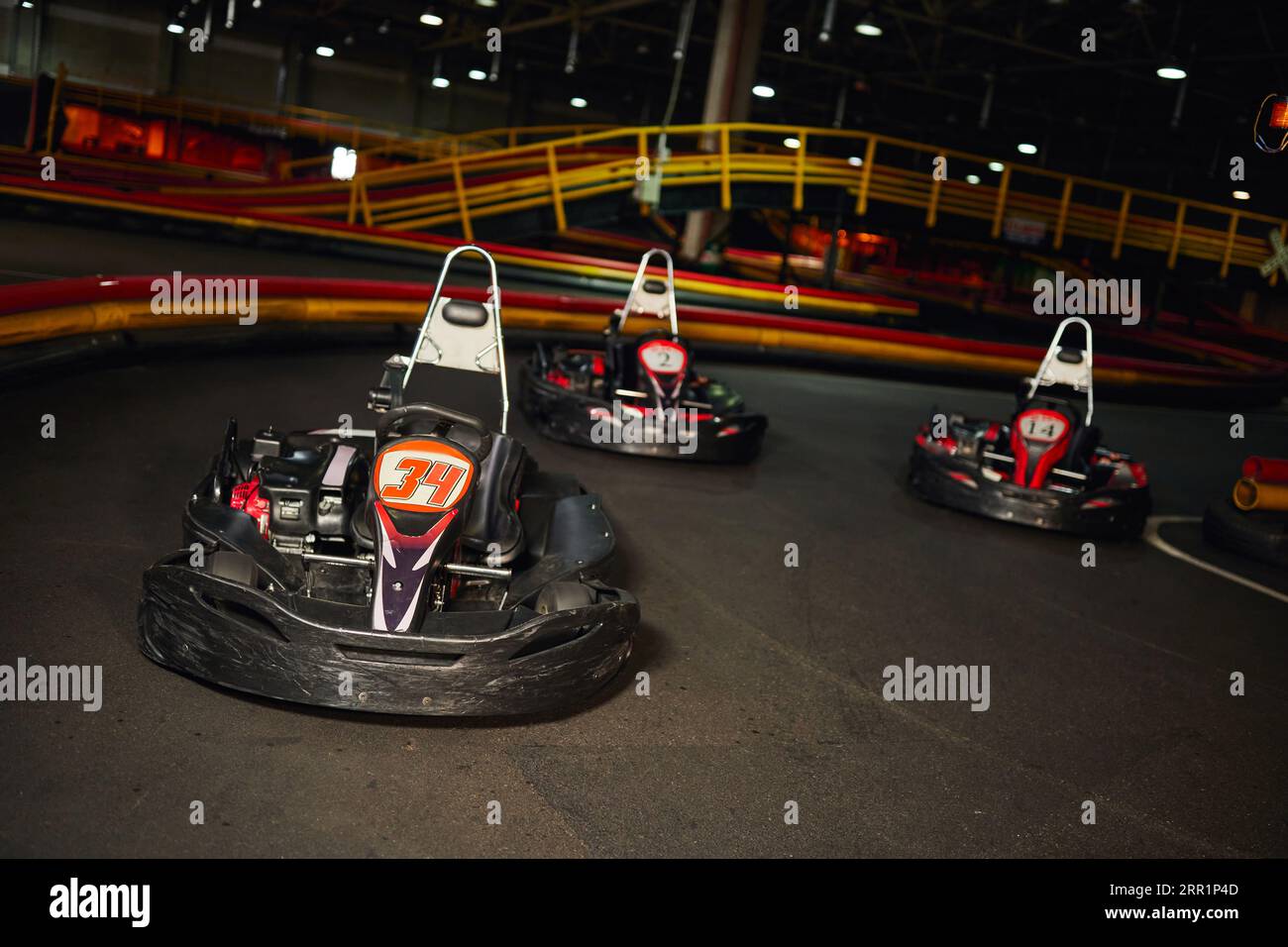 modern racing cars inside of indoor kart circuit, motor race vehicles ...