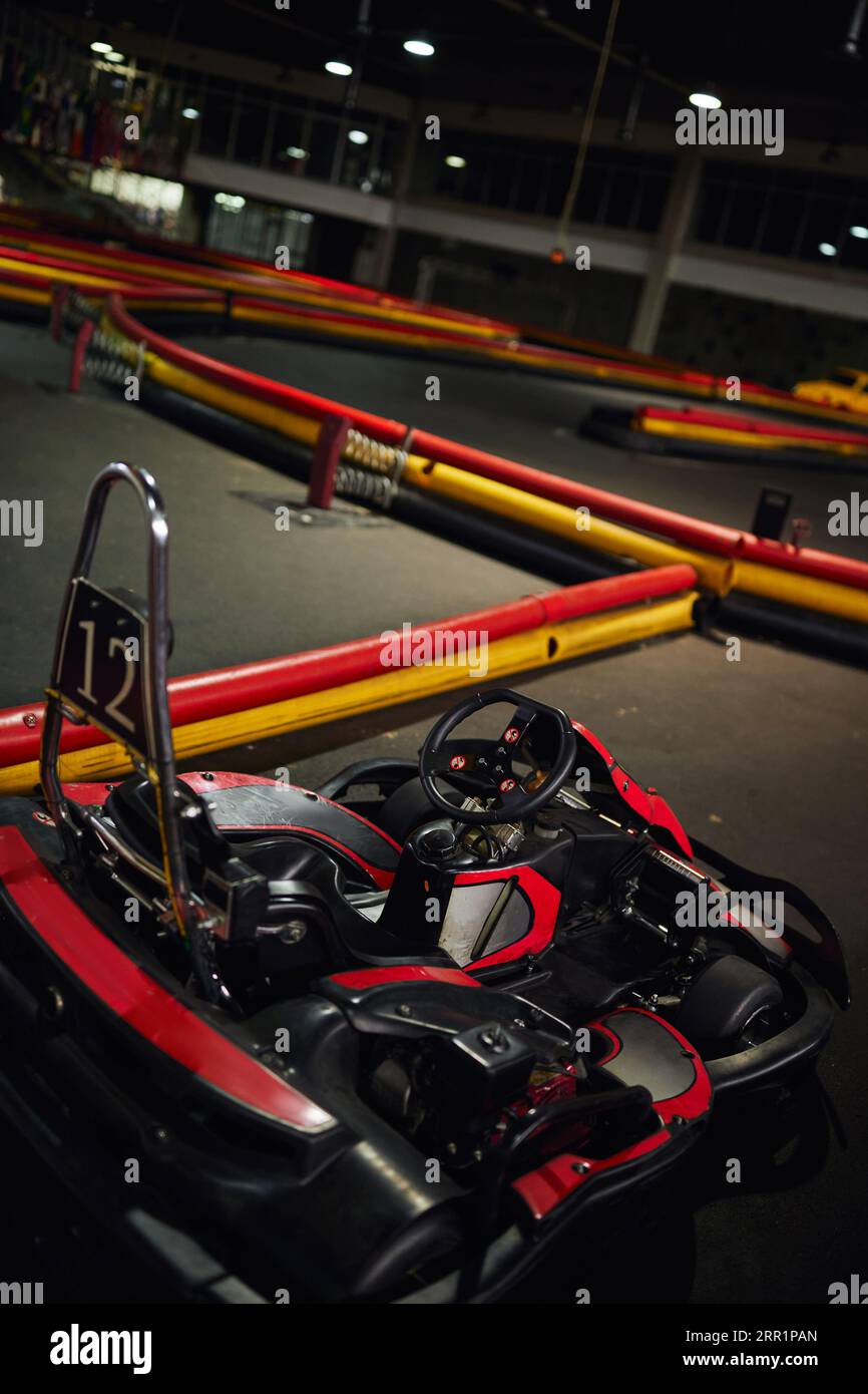 design of red racing car inside of indoor kart circuit, motor race ...