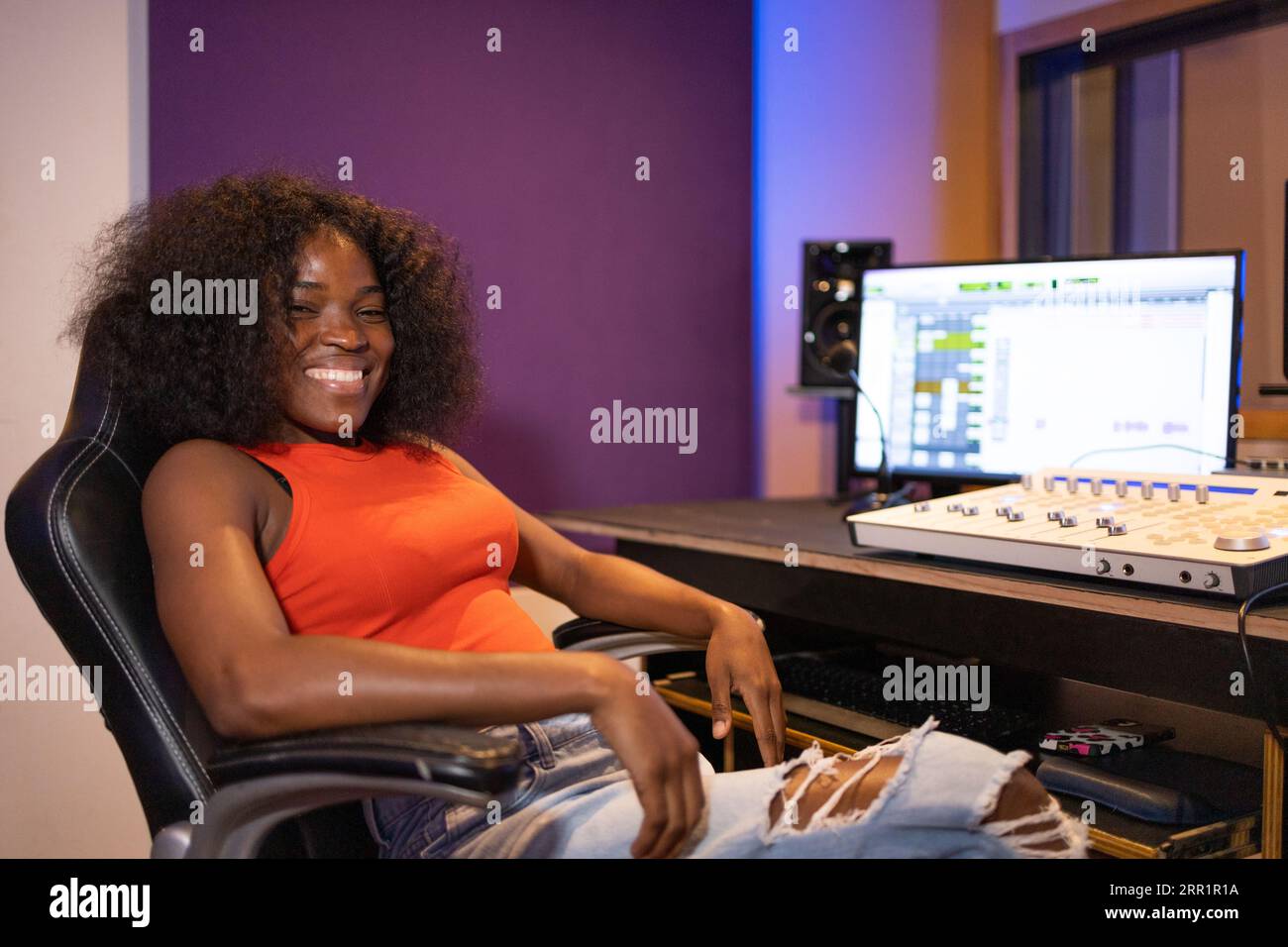 Portrait of glad African American female audio engineer working in ...