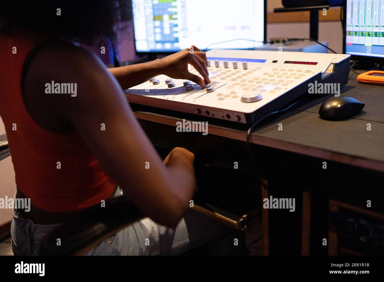 Crop anonymous African American female audio engineer creating music ...