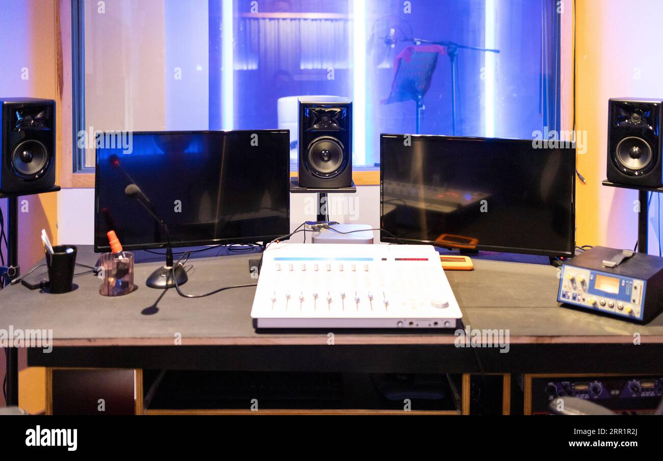 Podcast studio room table with computer monitors microphone on tripod ...