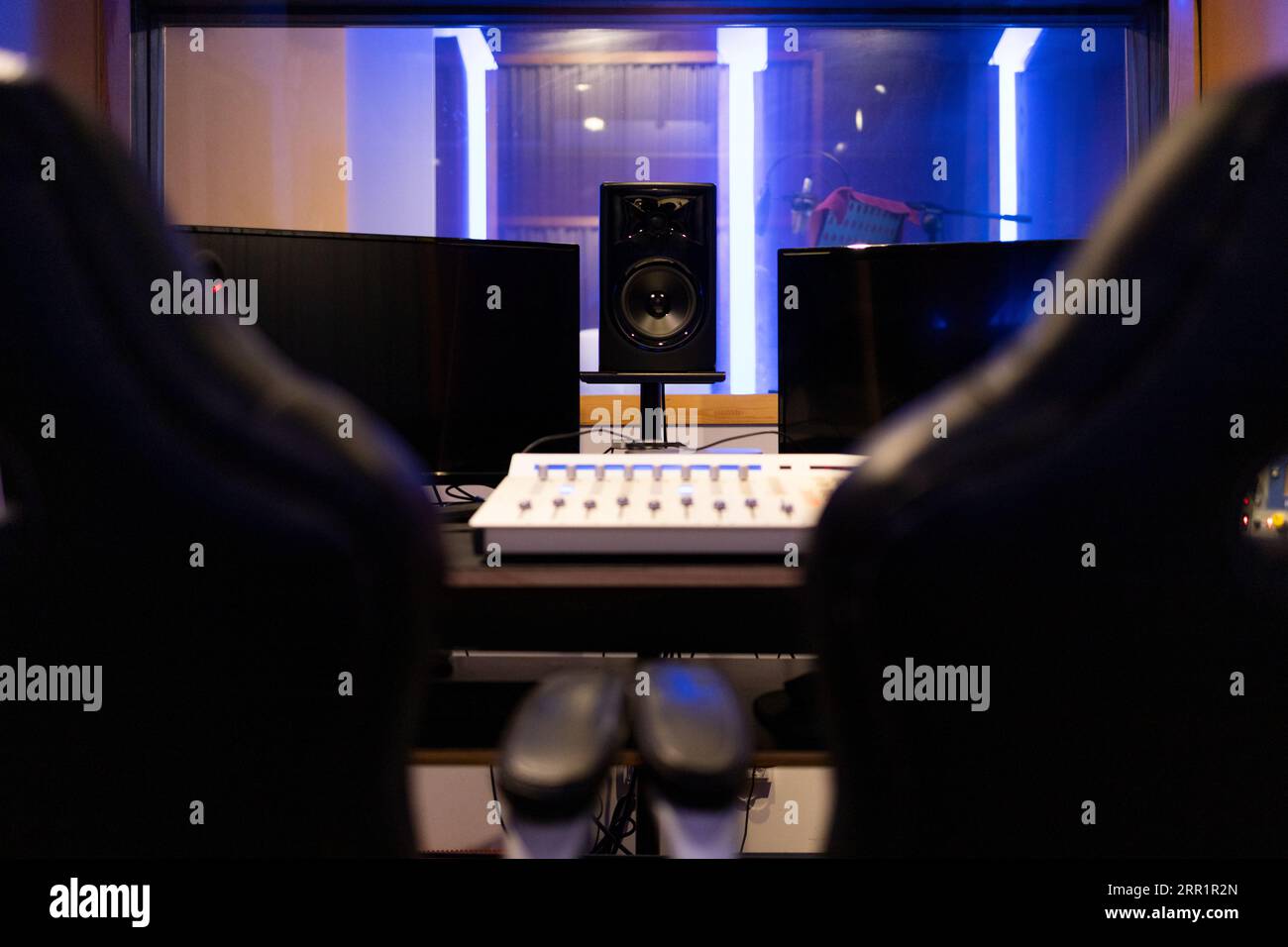 Podcast studio with empty armchair with headrest and table with blurred ...