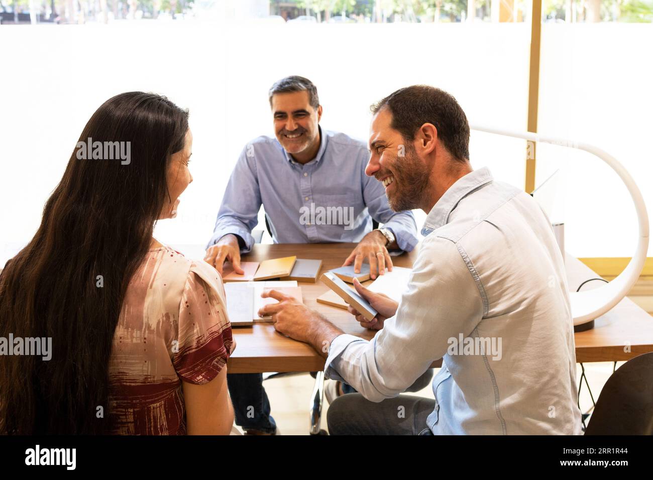 Happy clients with material samples of facades of kitchen cabinets and ...