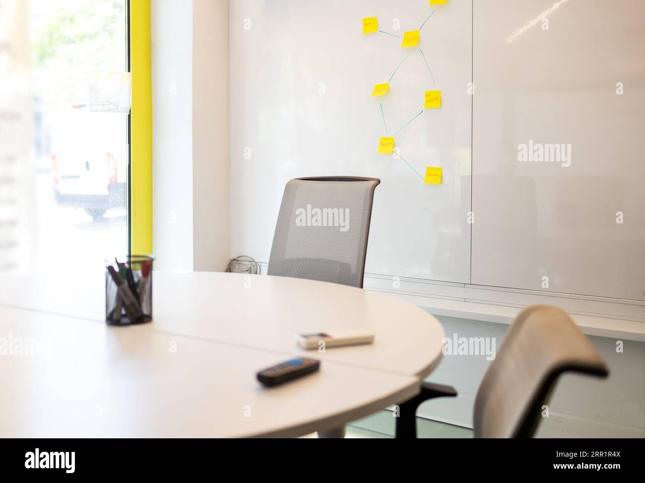 Interior of contemporary office room with round table and chairs placed ...