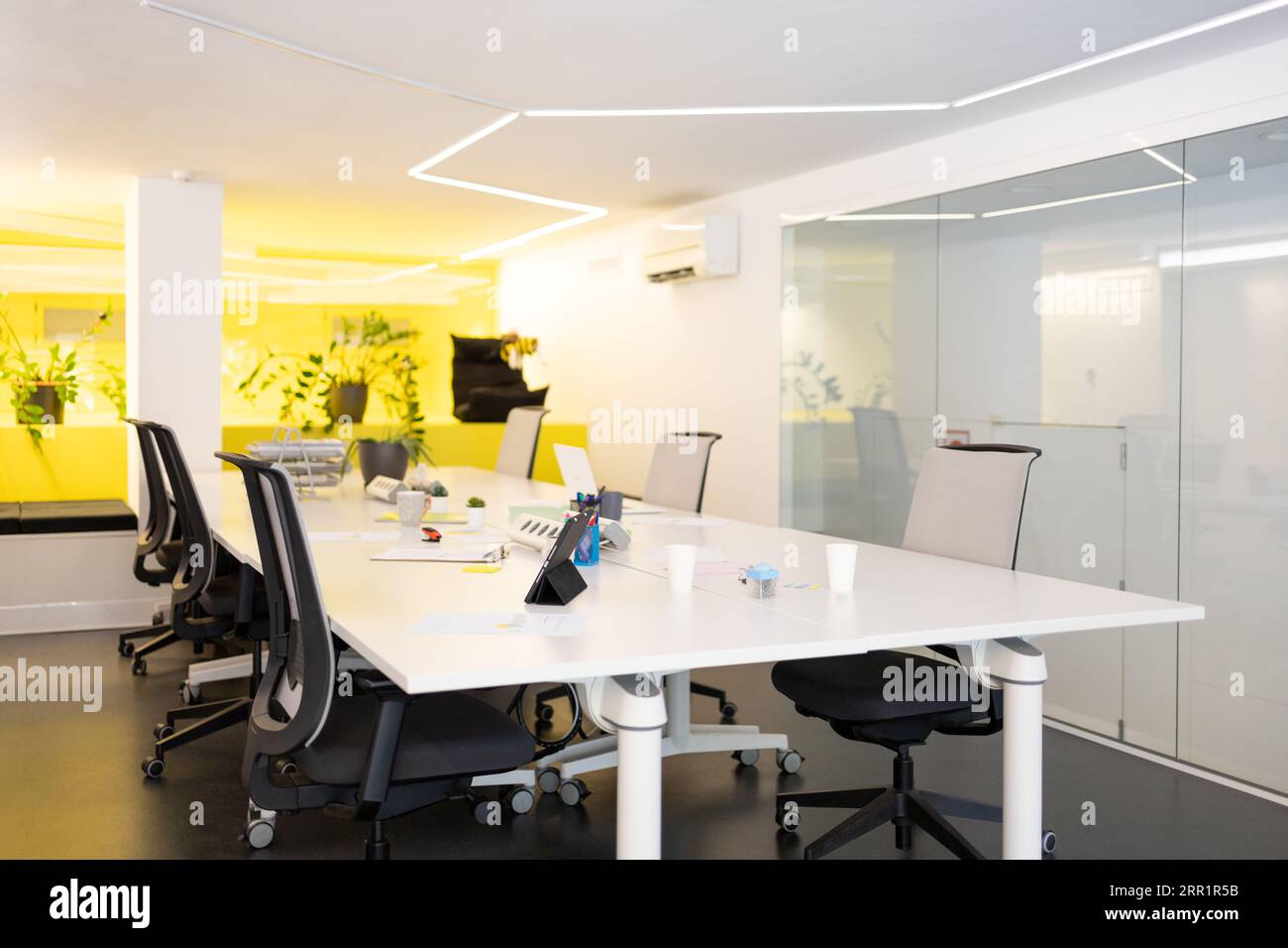 Office meeting room with writing board long table with tablet chairs ...