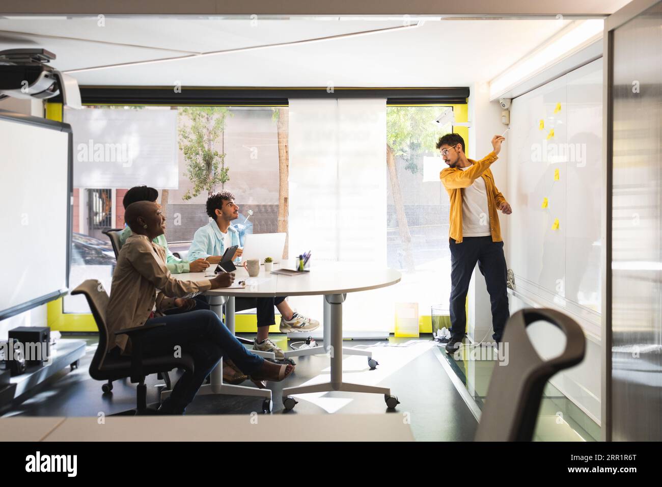 Side view of multiethnic colleagues gathering together in modern office ...