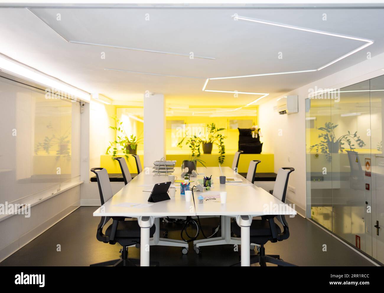Office meeting room with writing board long table with tablet chairs ...