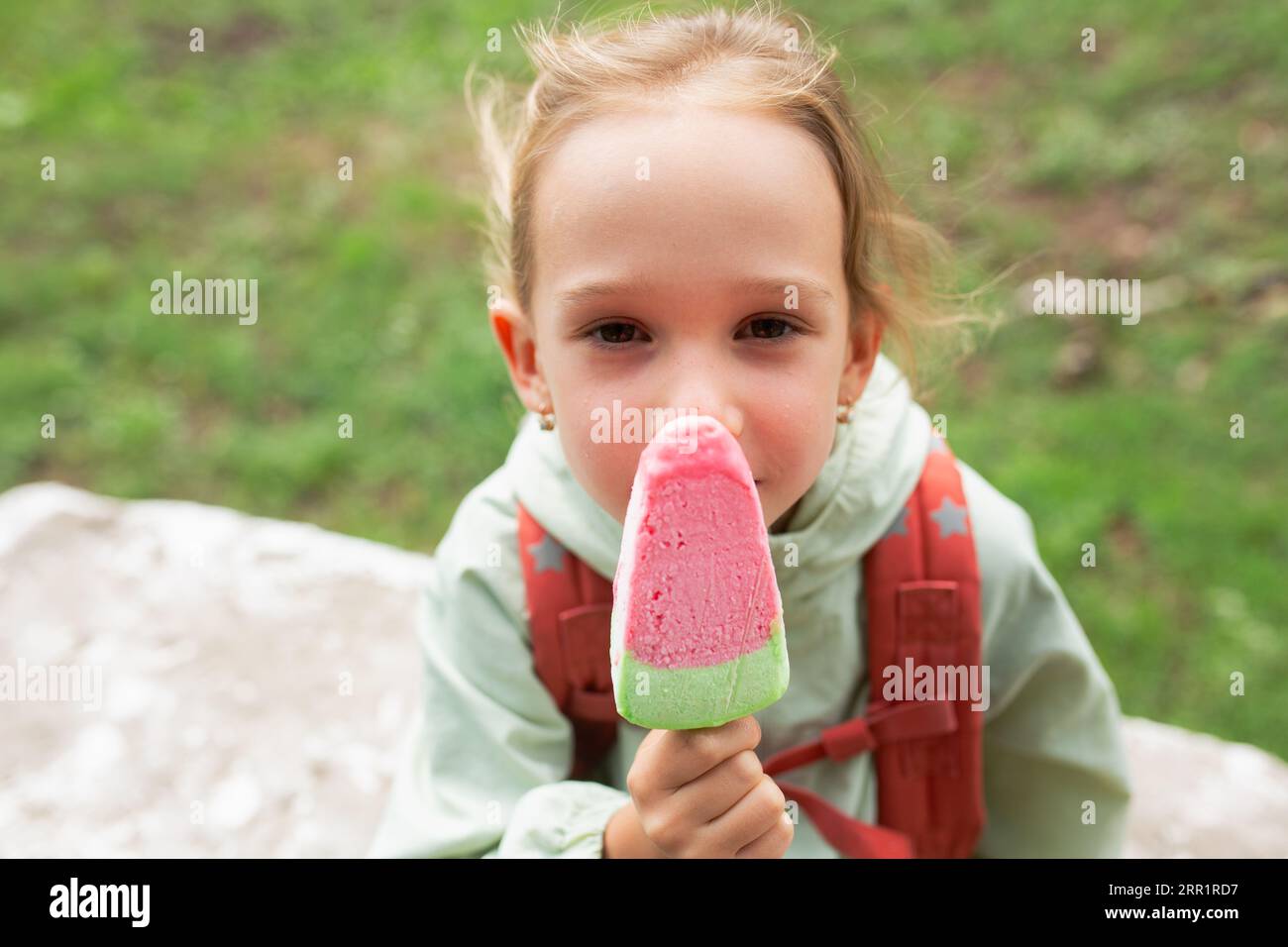 Cute smiling girl child with backpack looking at camera while standing ...