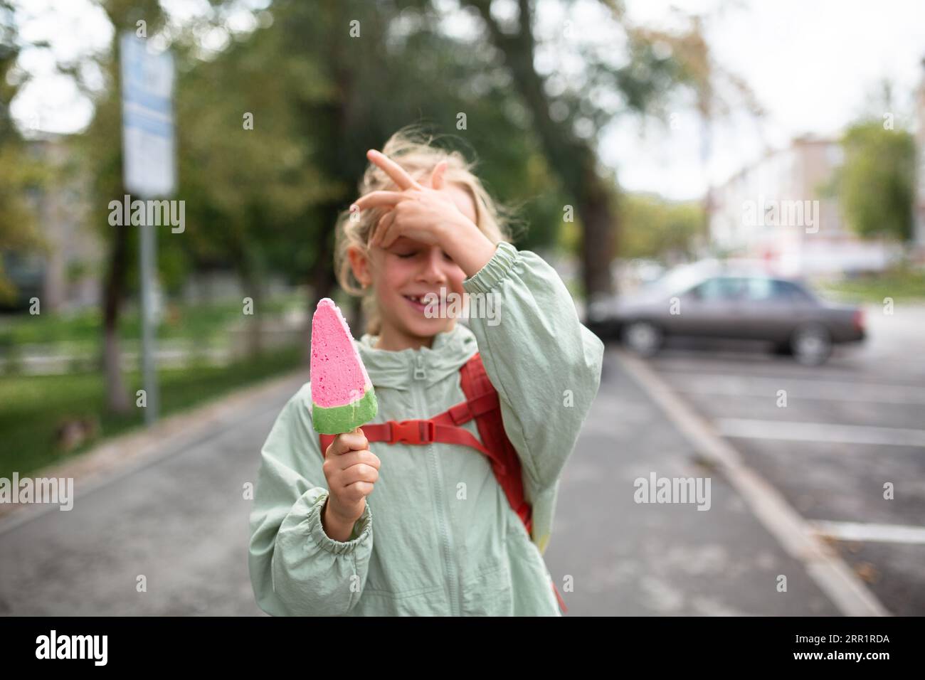 Cute smiling girl child with backpack with eyes closed while standing ...