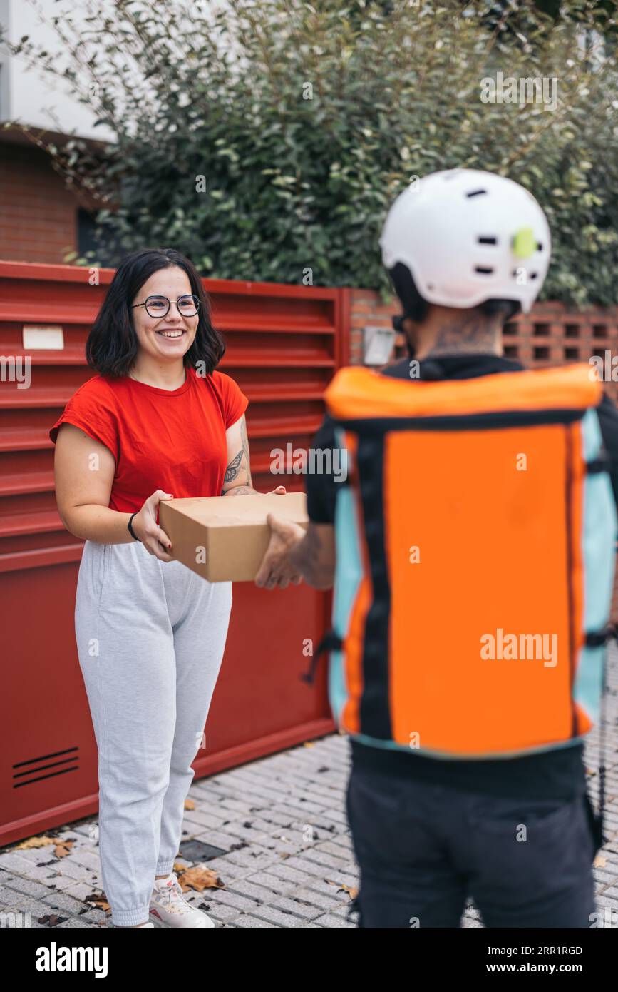 Woman receiving clothes shipment hi-res stock photography and images ...